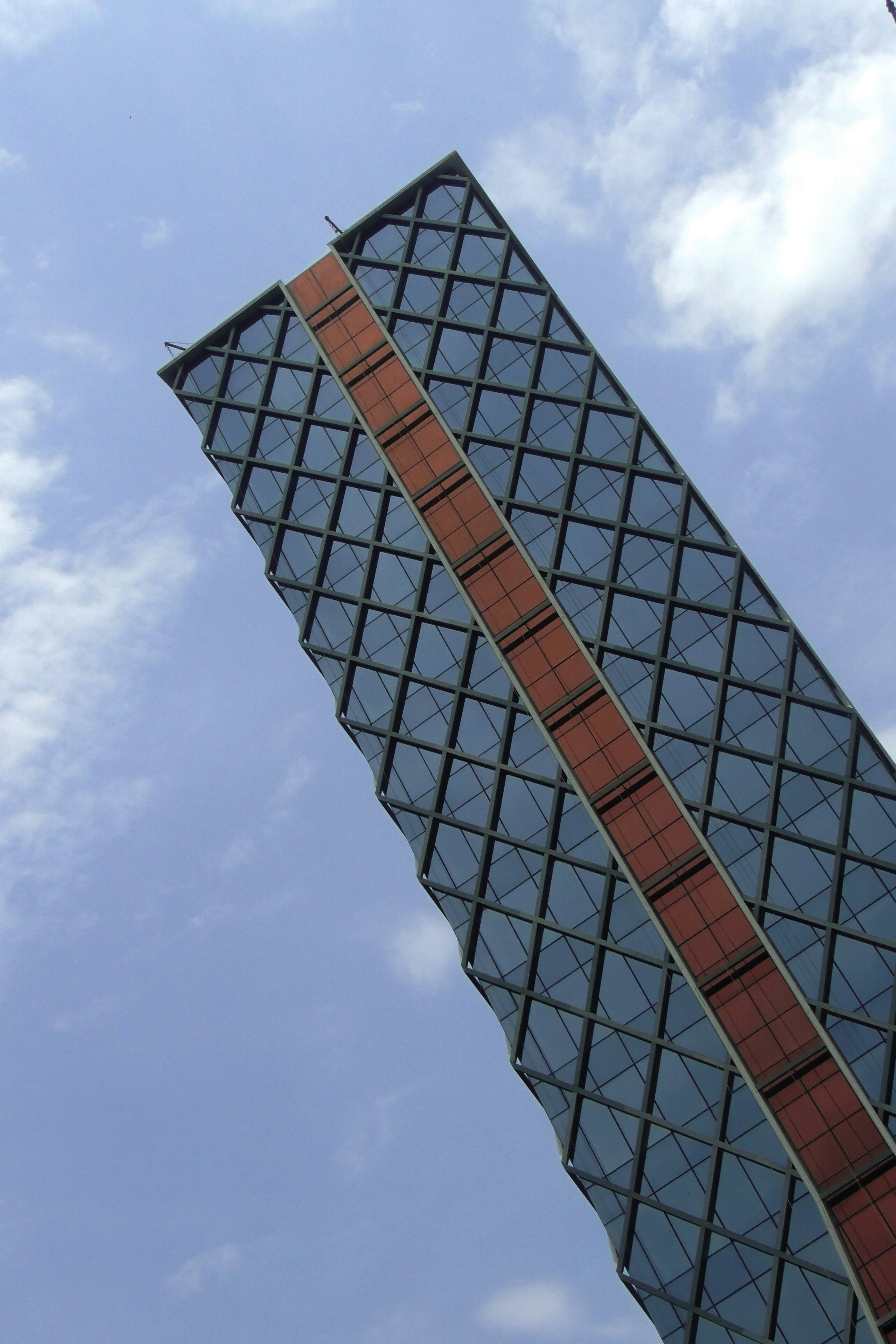 Diagonal Glass Monument: A Tilted Tower Sliced by a Red Ribbon