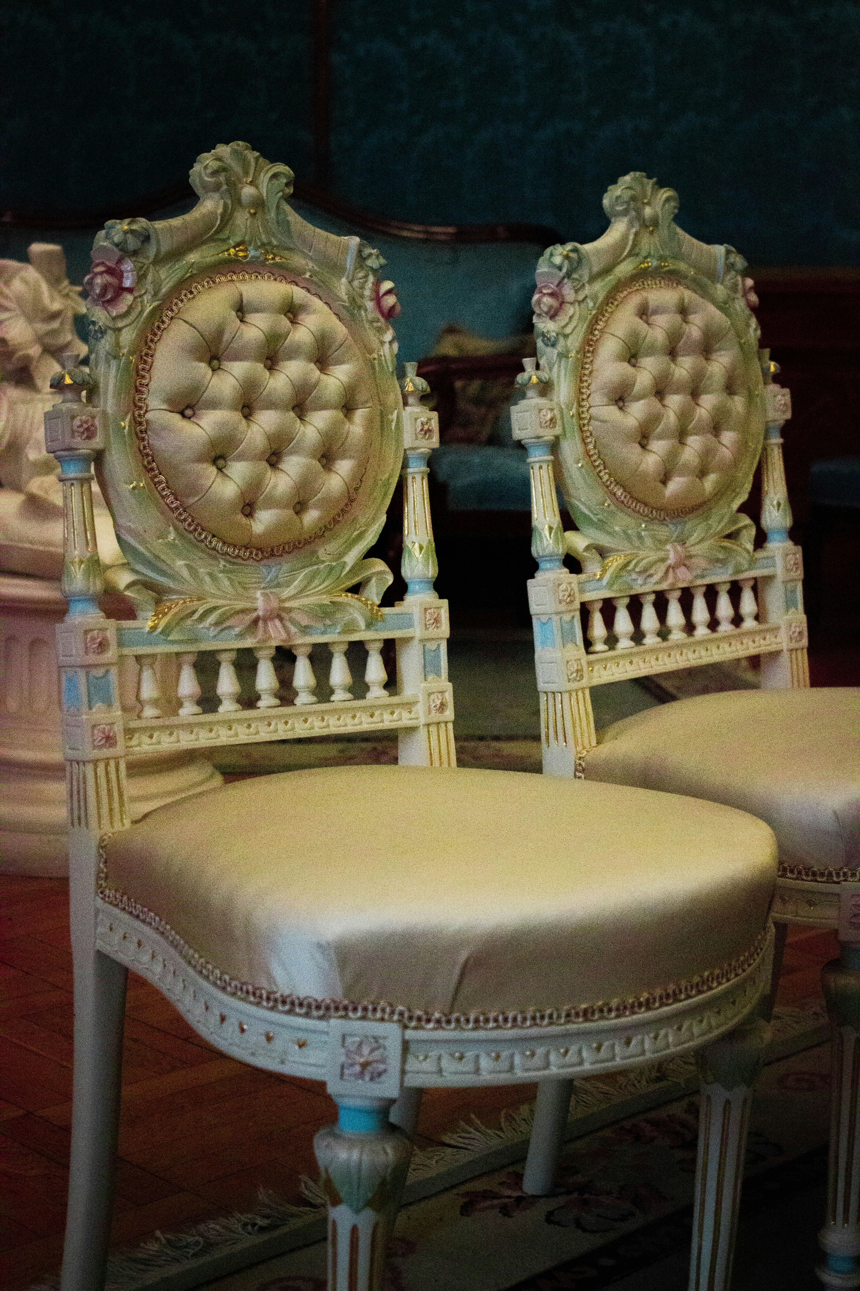 Rococo Reverie: Paired Ivory Tufted Chairs in a Velvet Parlor