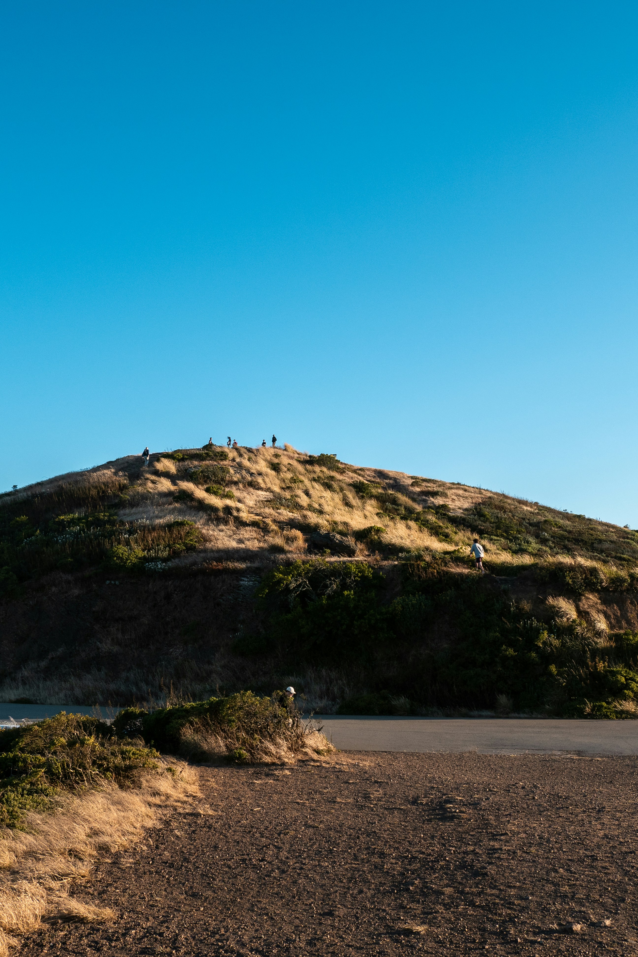A view of a hill from the top of a hill photo – Free Blue Image on Unsplash