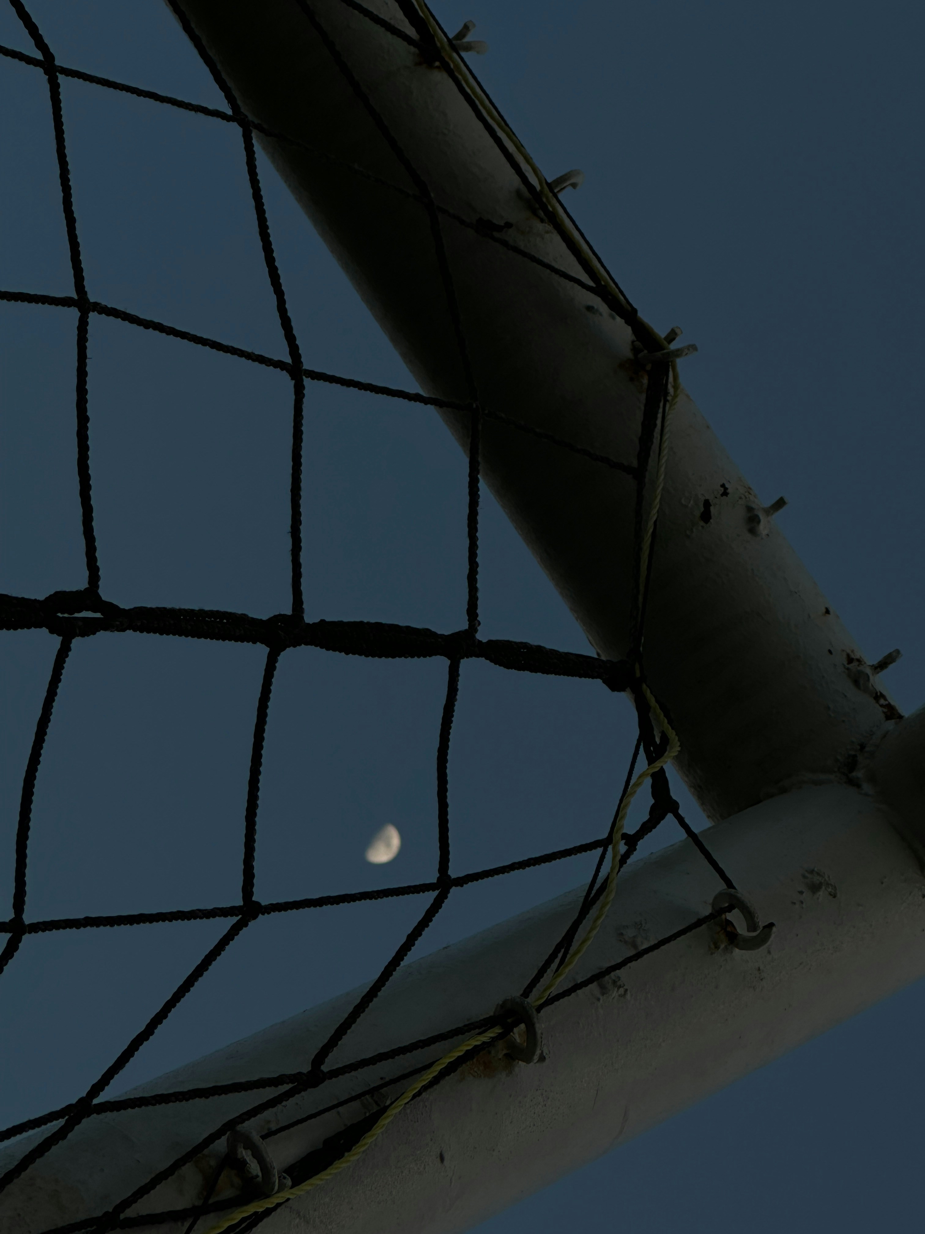 Moon Through the Mesh: Night Shot by the Fence