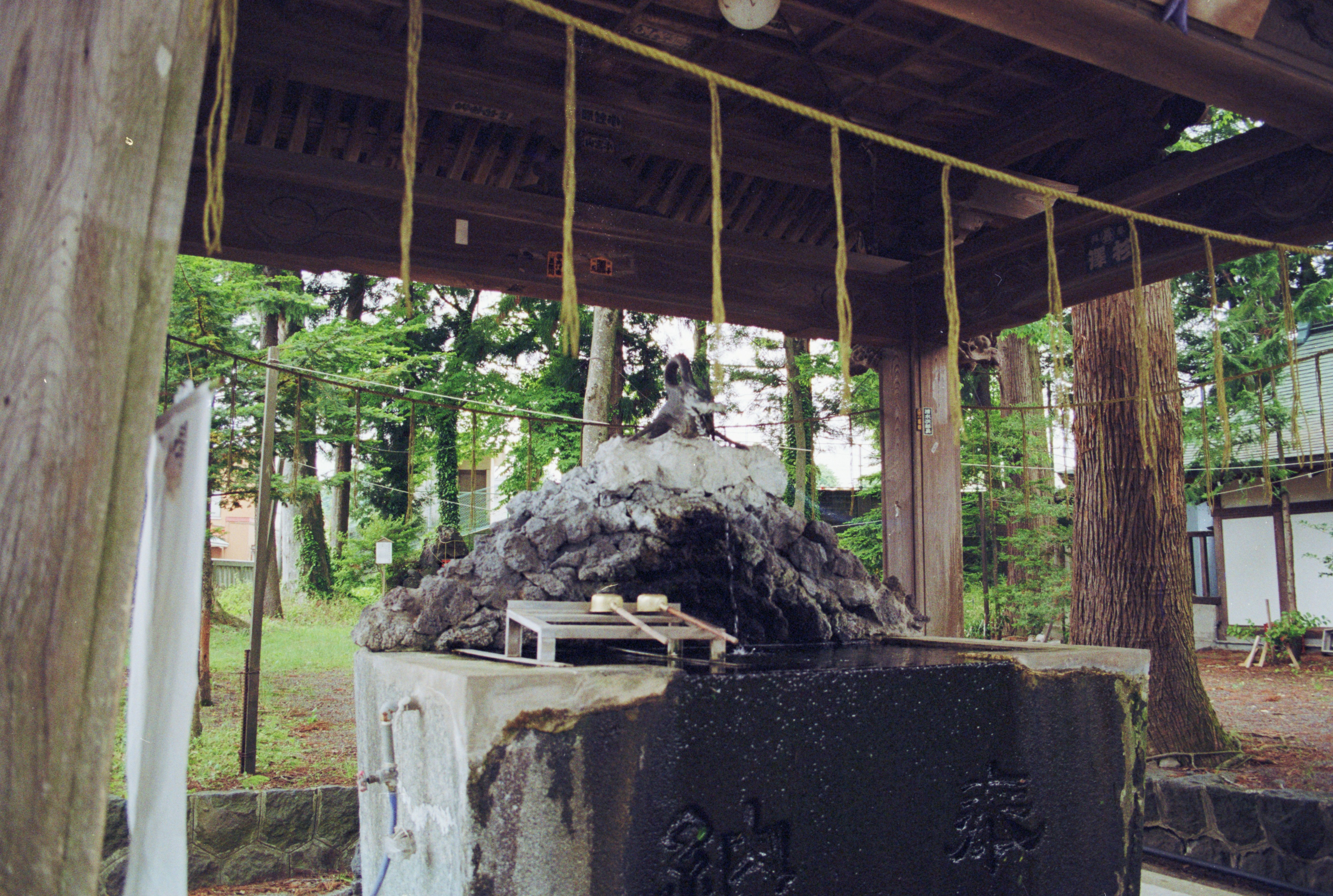 Rock Purification: A Shinto Shrine Altar Under a Wooden Shelter