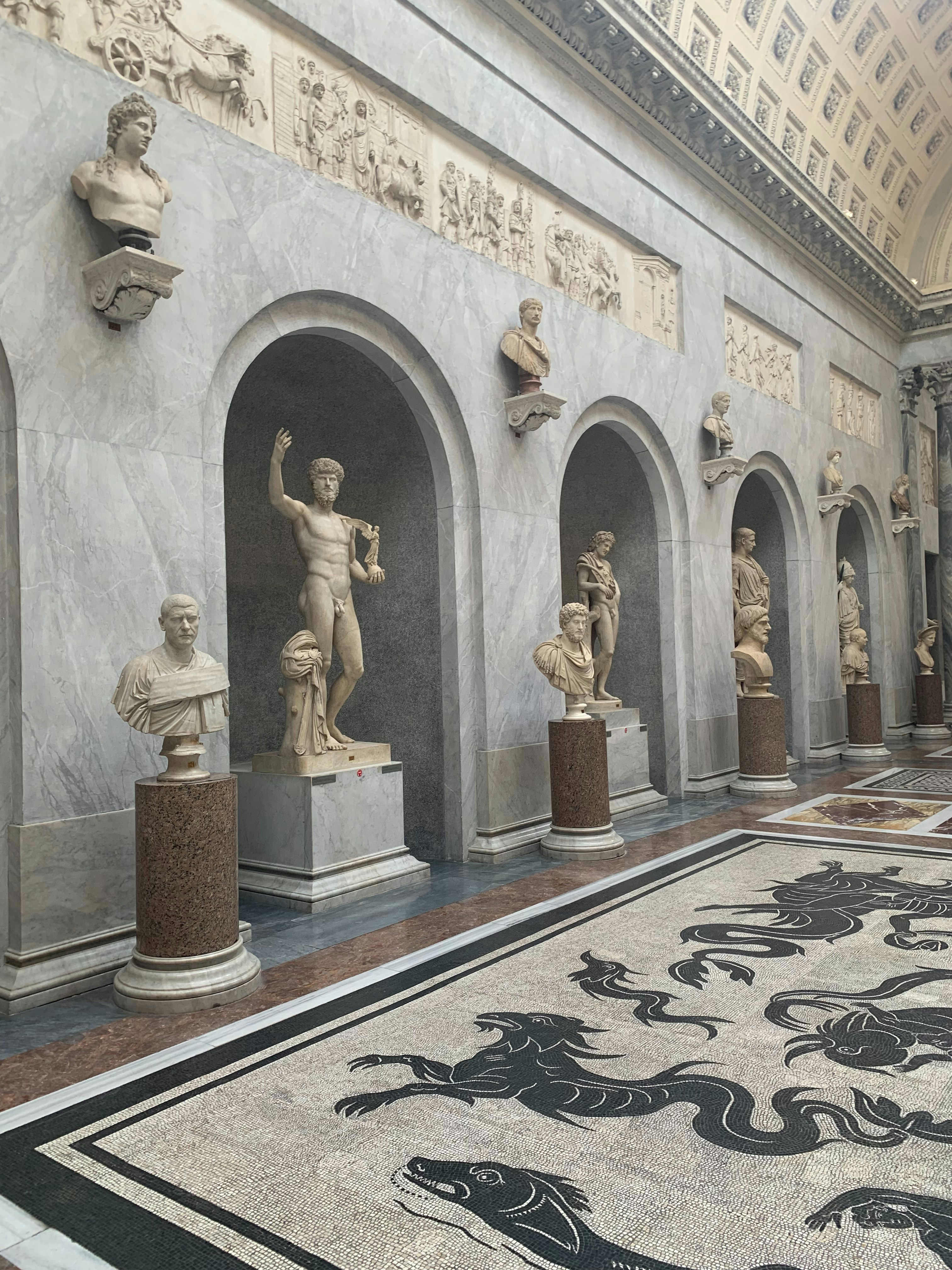 A room filled with statues of men and women photo – Free Grey Image on ...