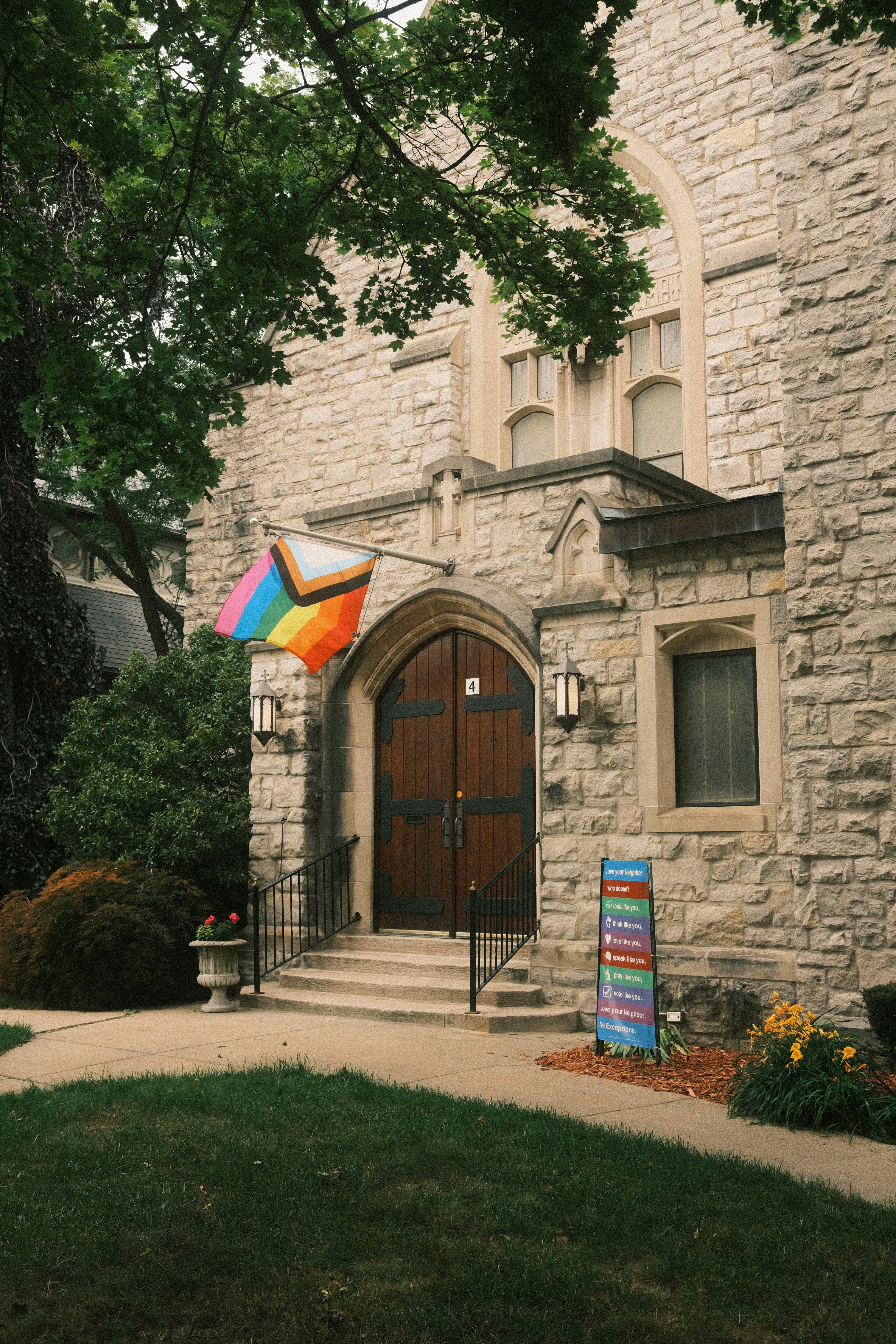 Rainbow Flag Over a Stone Church: A Quiet Façade of Heritage