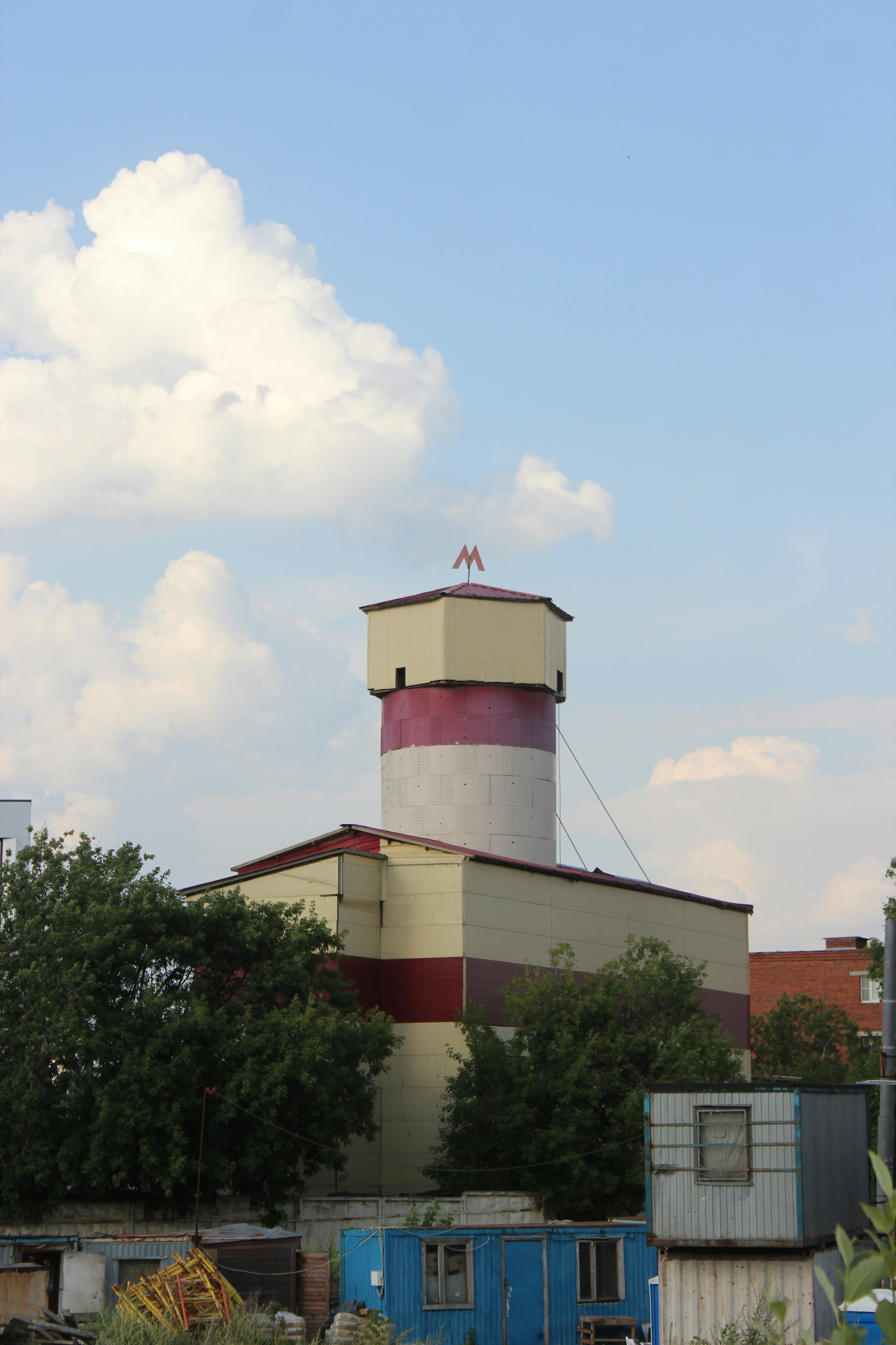 A large building with a red and white tower photo – Free Building Image ...
