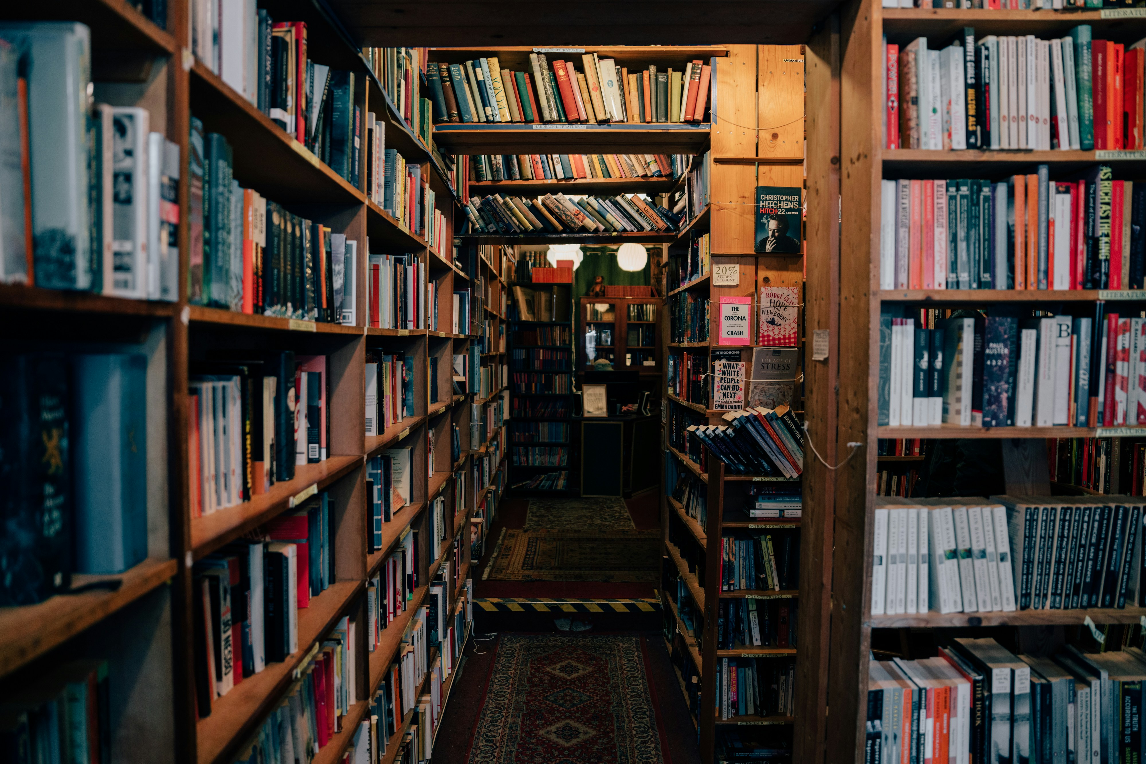 A long narrow bookshelf filled with lots of books photo – Free ...