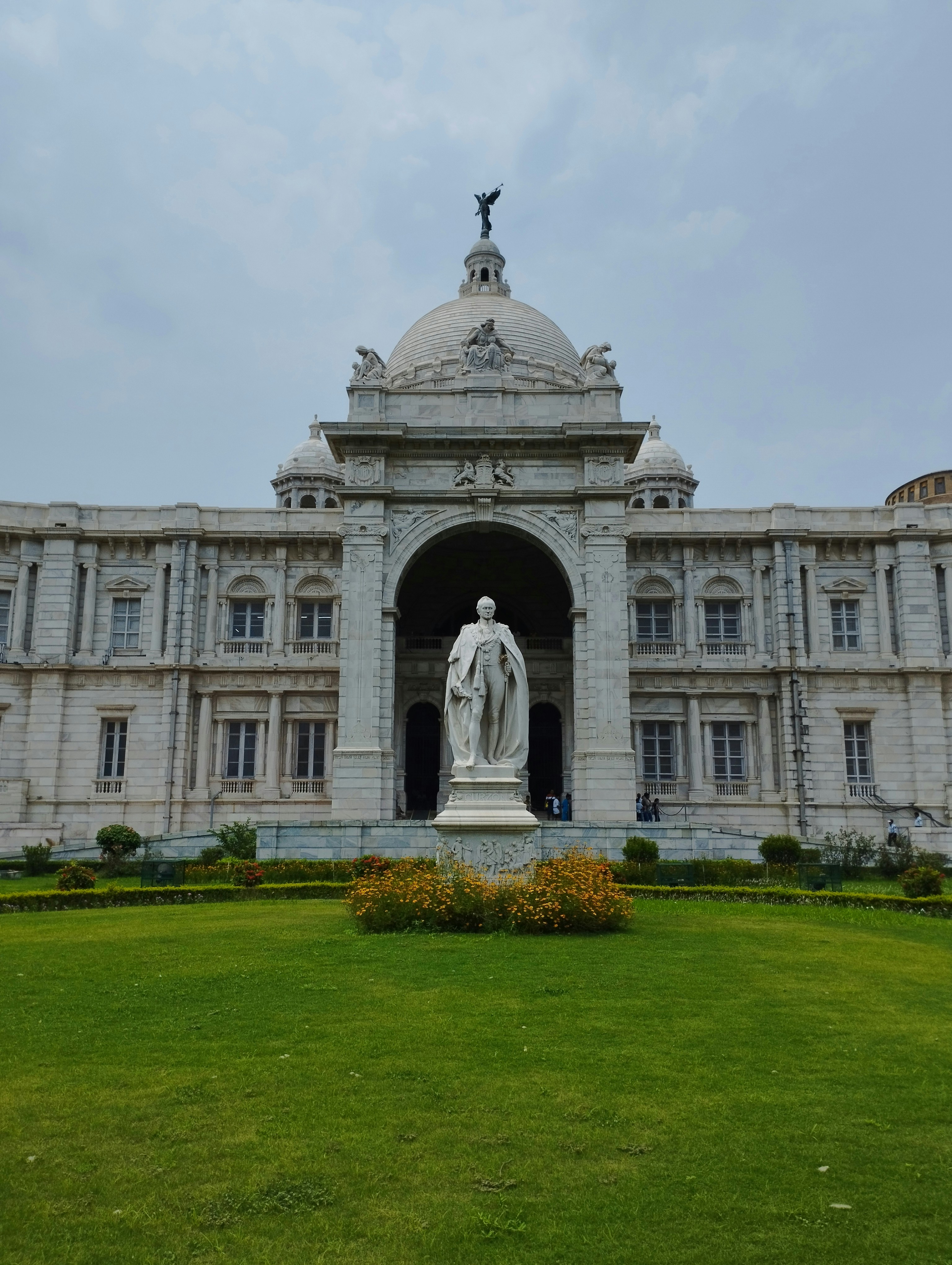A large building with a statue in front of it