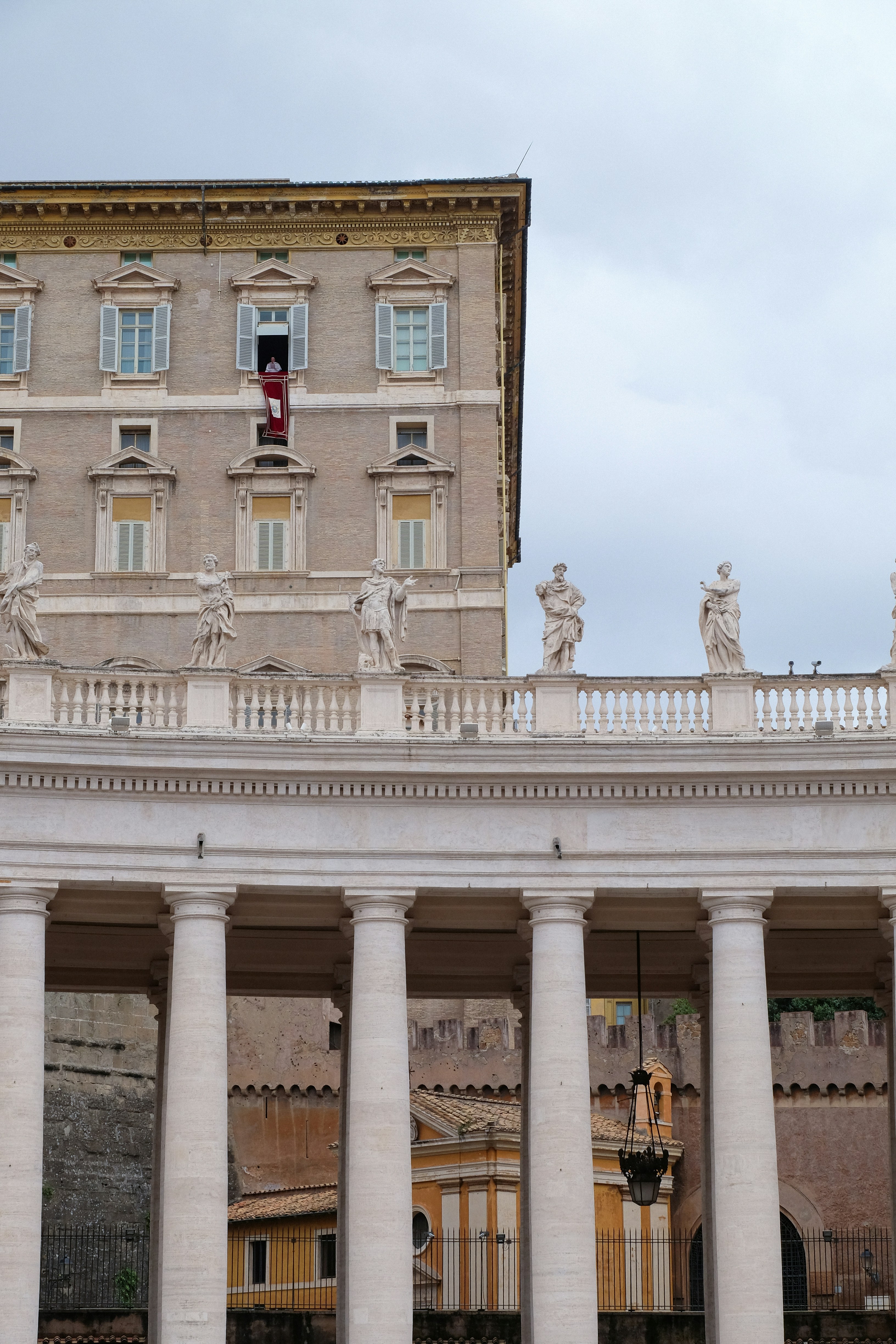 A very tall building with a bunch of pillars in front of it photo ...