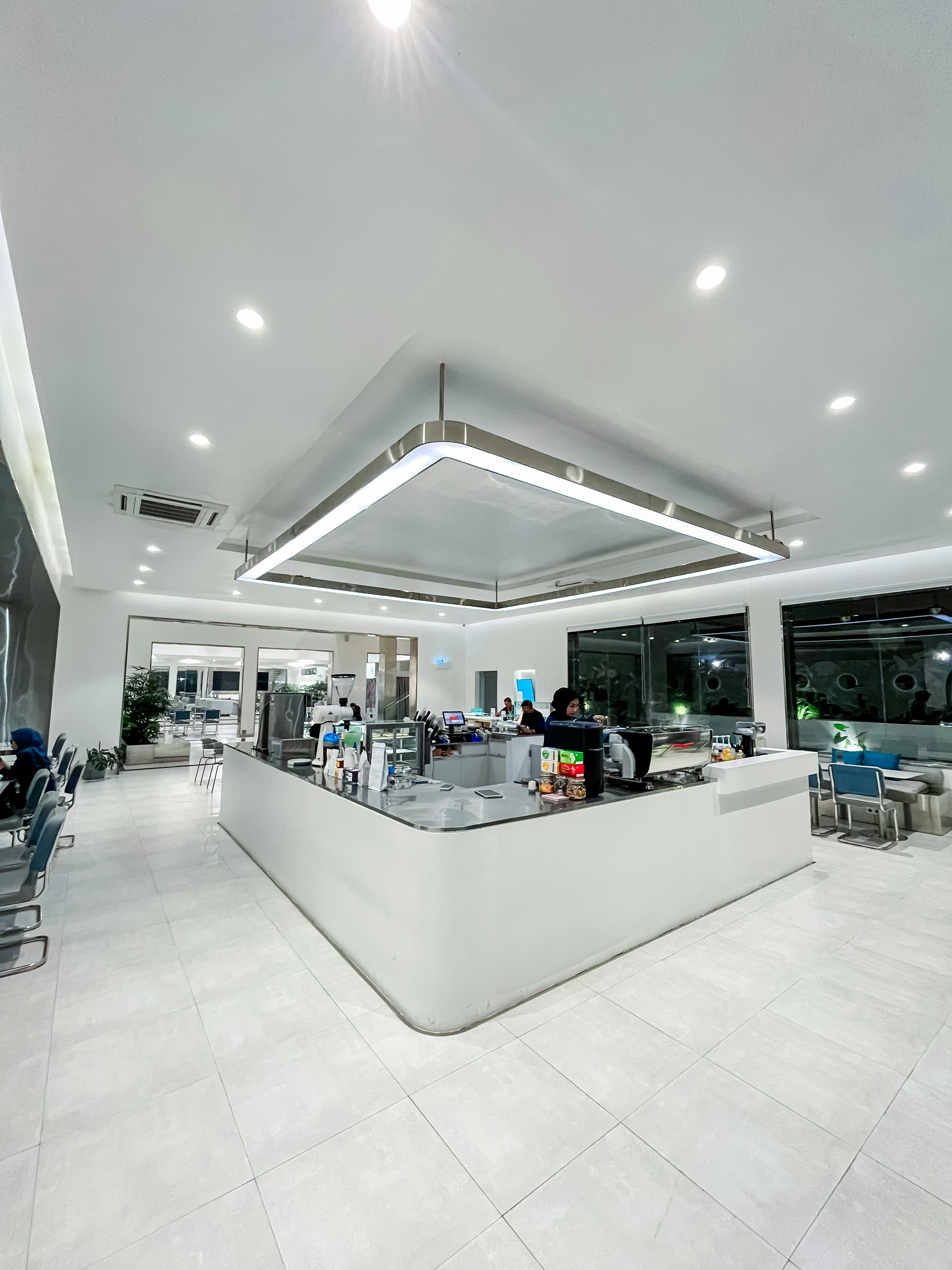A restaurant with tables and chairs and a skylight photo – Free Human ...