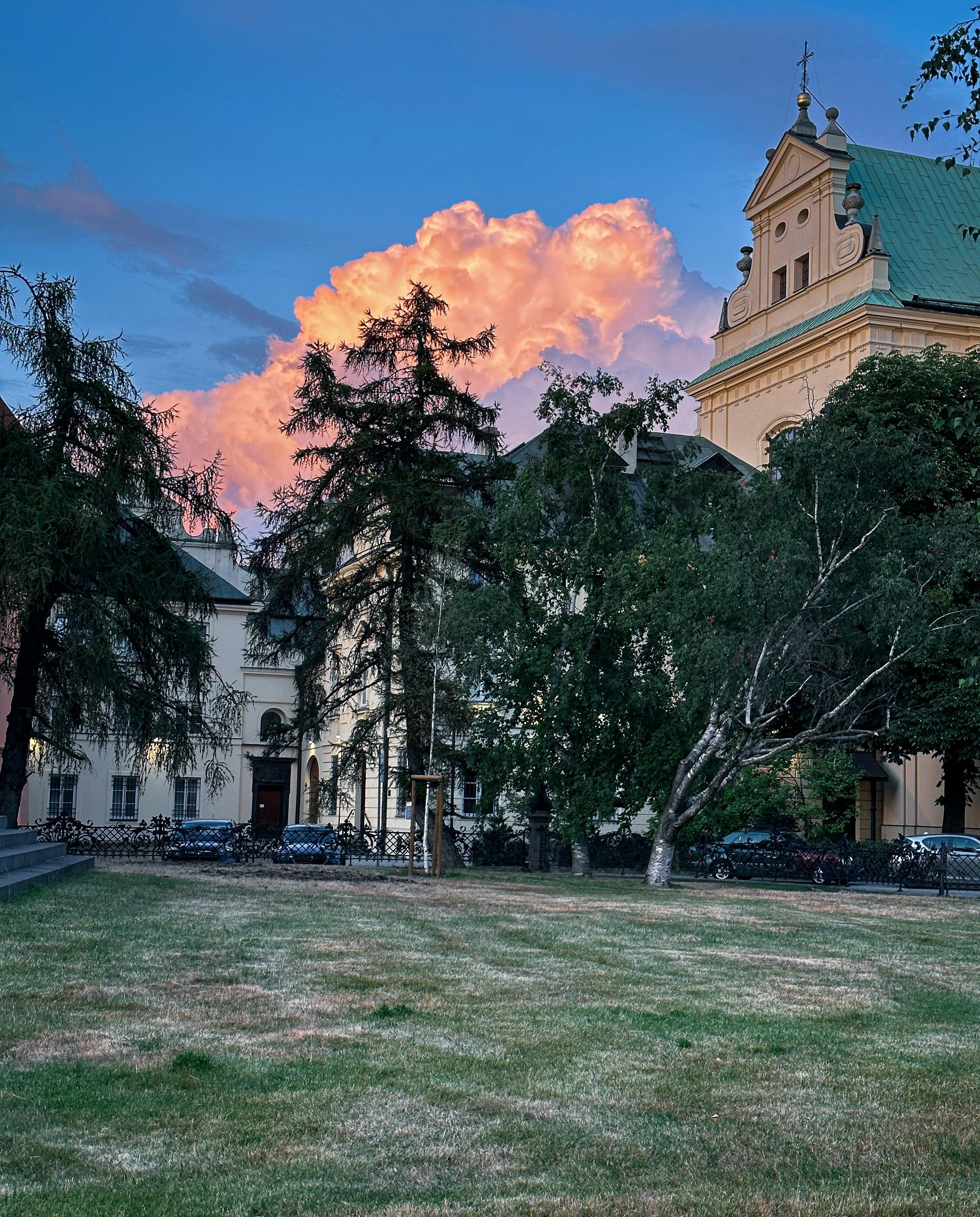 Peach-Cloud Crown Over a Quiet Campus Courtyard