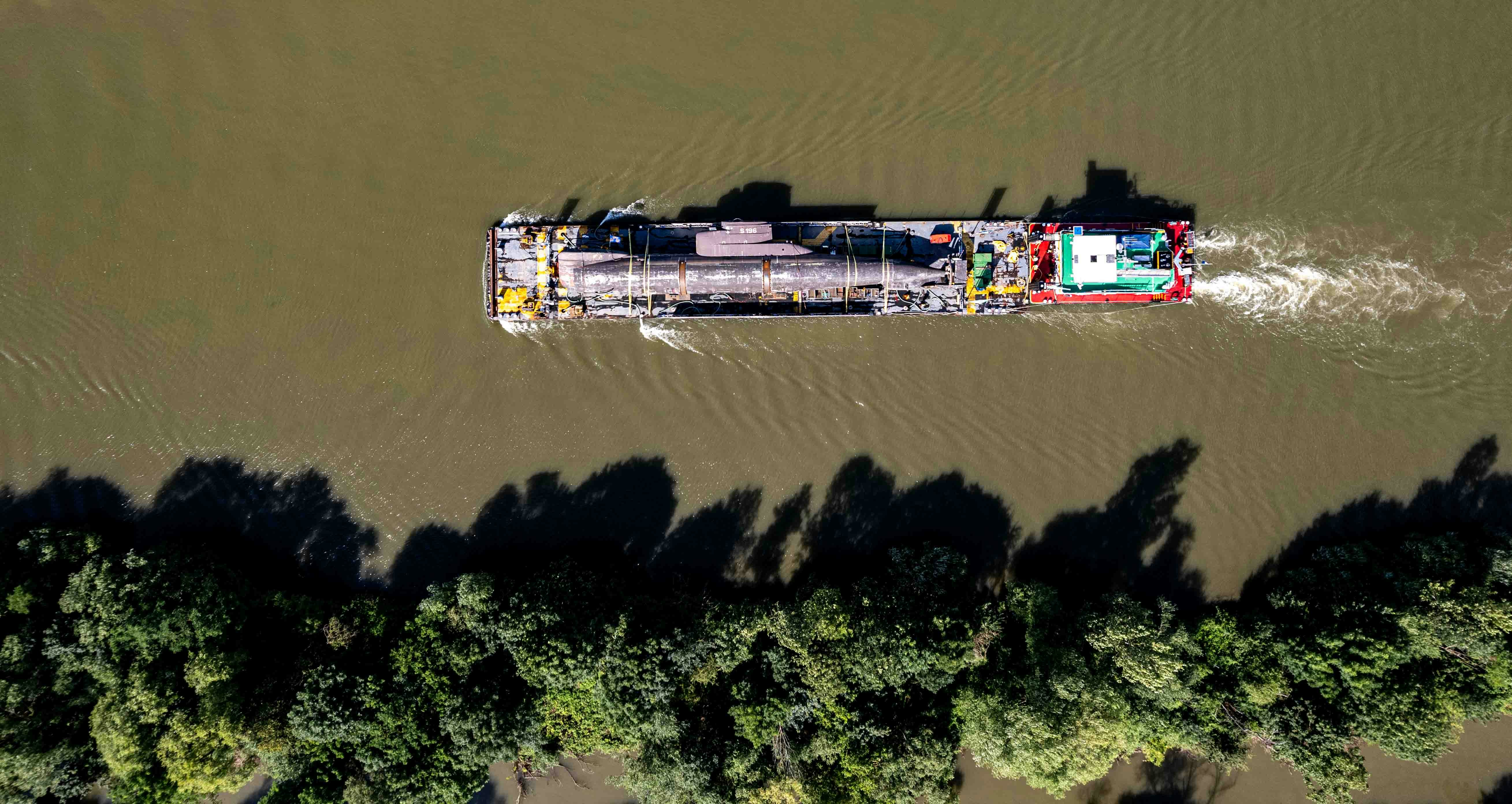 Aerial View: Towing Barge Rides the River Verge