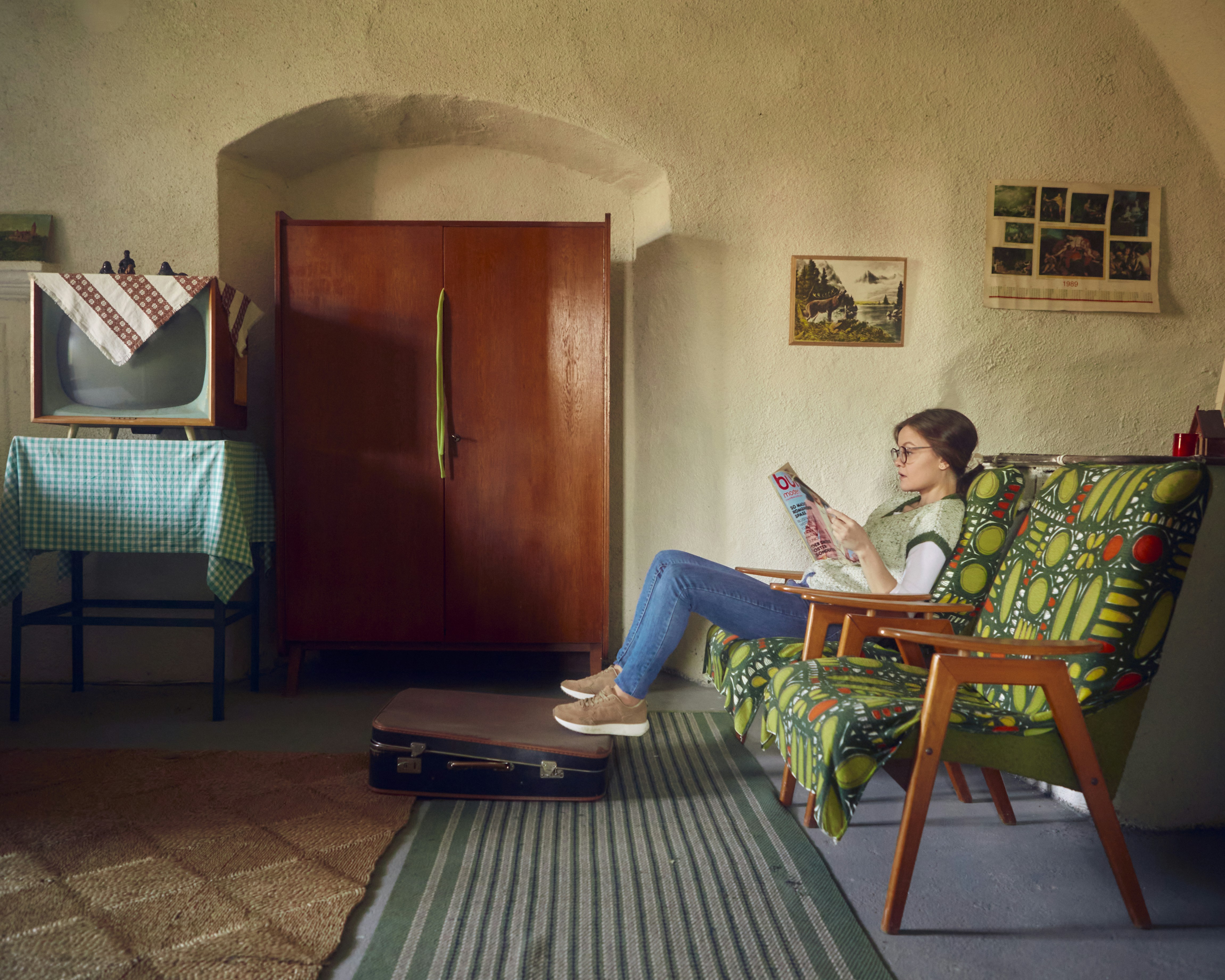 Sunlit Cozy Corner: A Woman Reading amid Retro Furnishings
