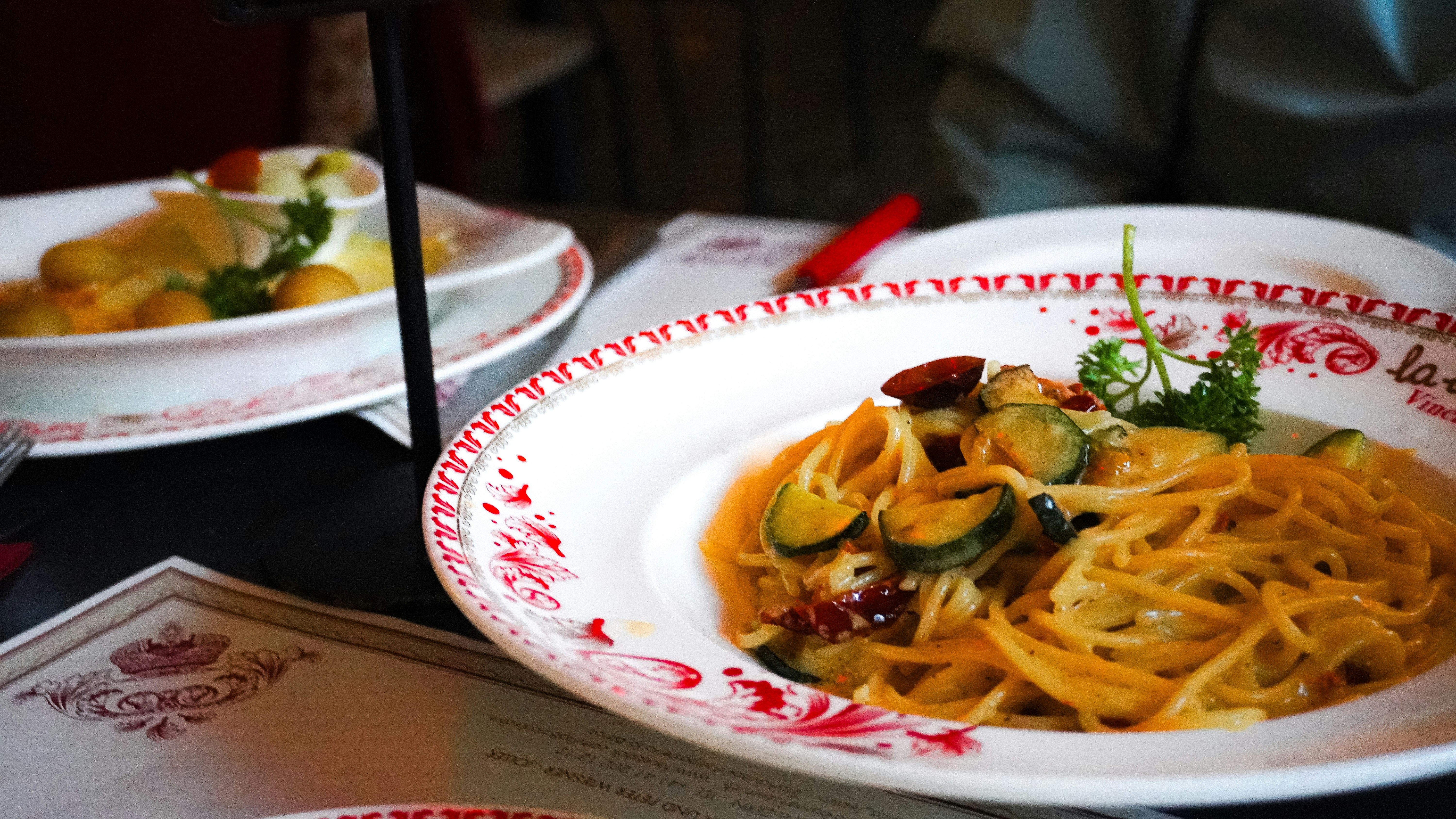 A plate of spaghetti and vegetables on a table photo – Free Food Image ...