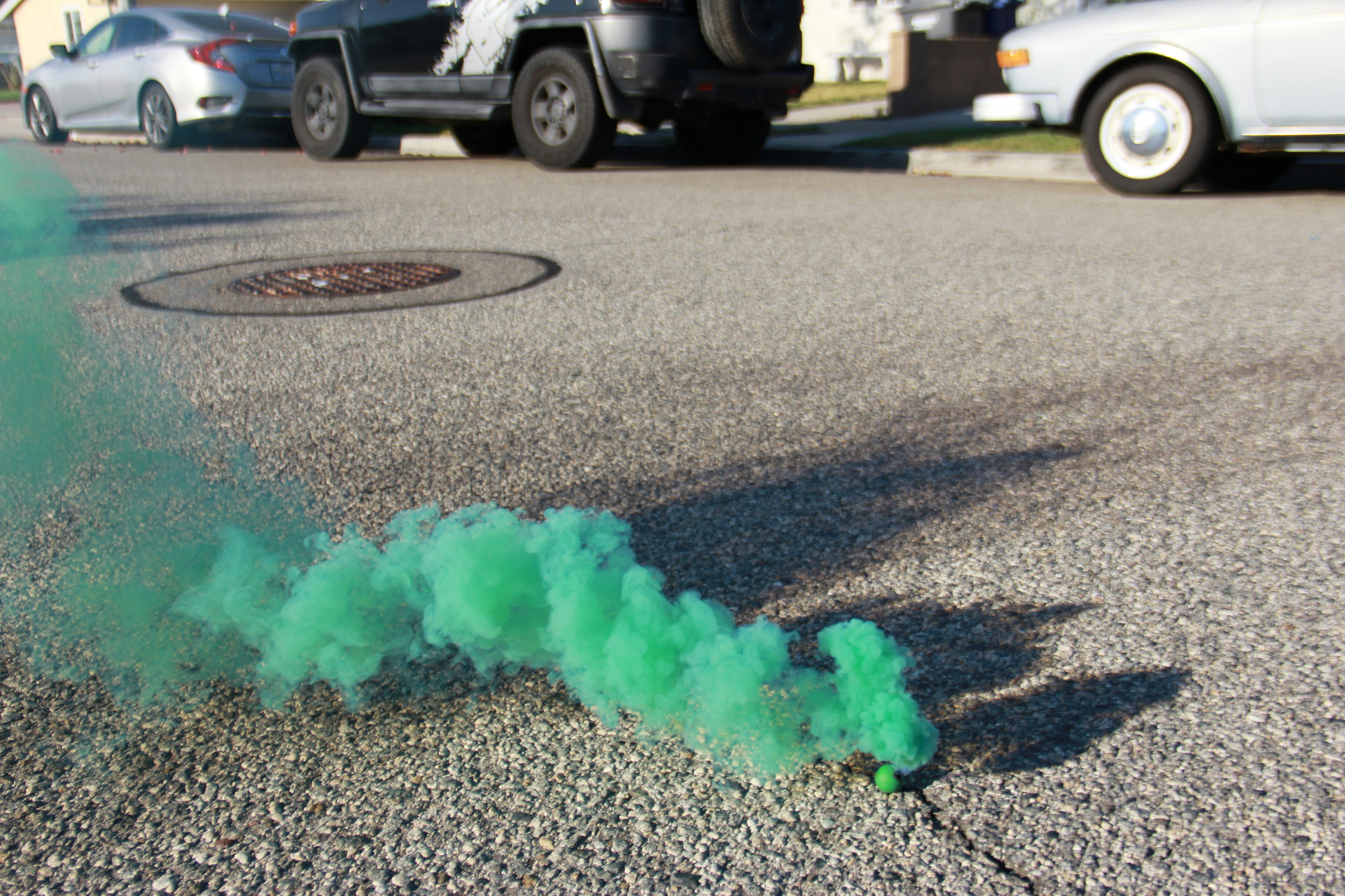 A fire hydrant spewing green smoke on a street photo – Free Car Image ...