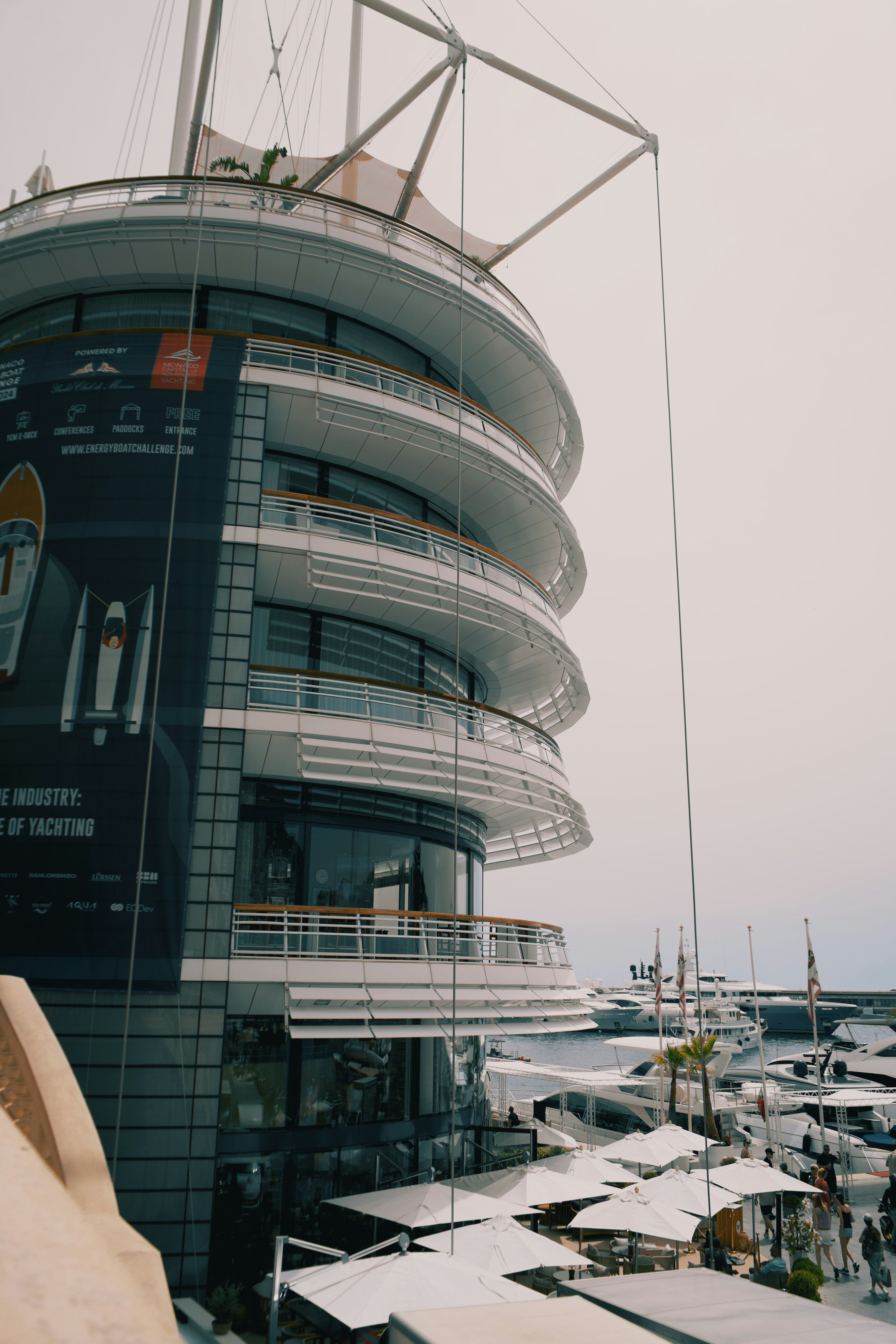 Circling Glass: A Marina Tower Framing Yachts in Soft Light