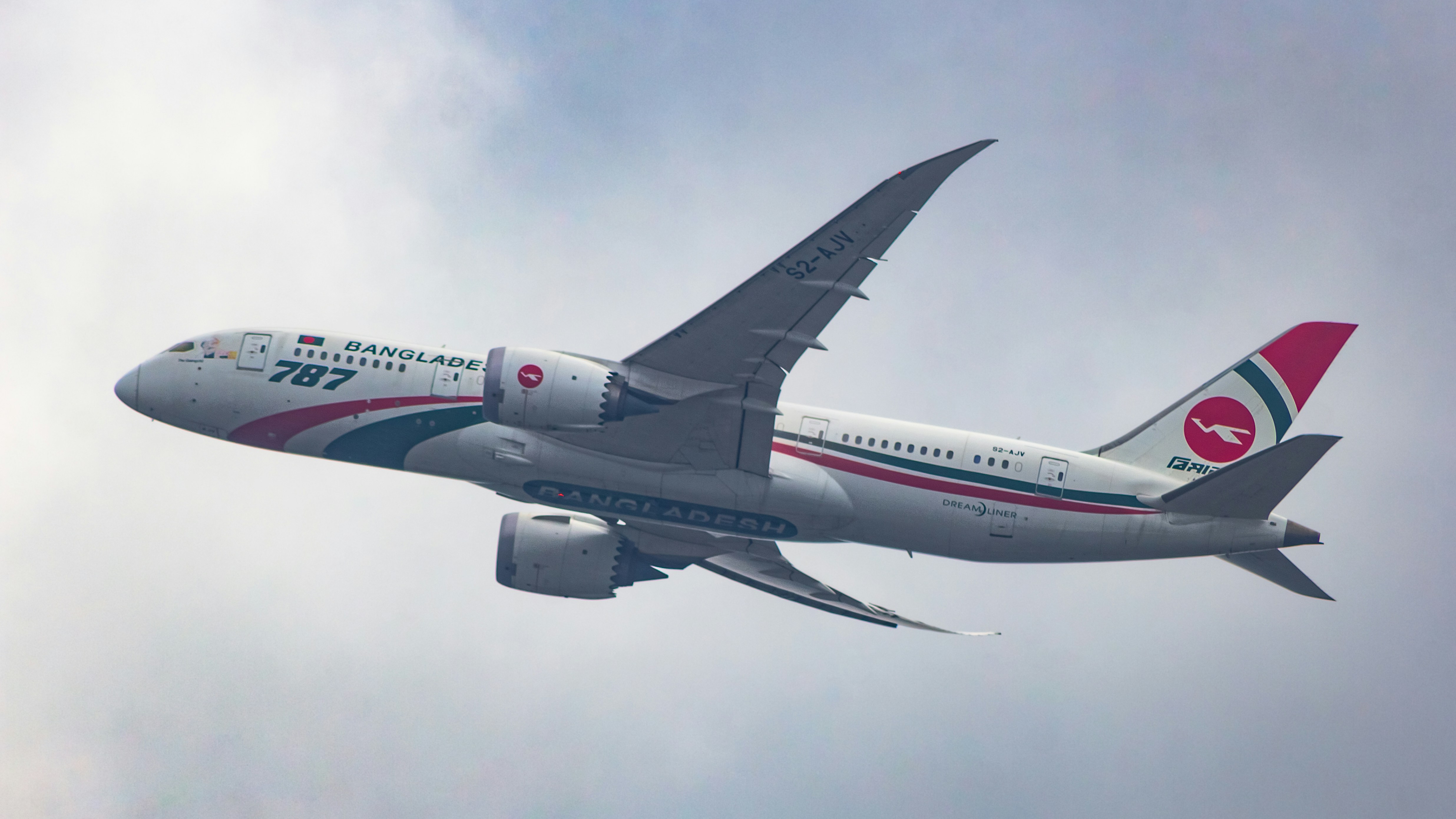 Bangladesh Airlines Boeing 787 ascends gracefully against a backdrop of soft clouds.