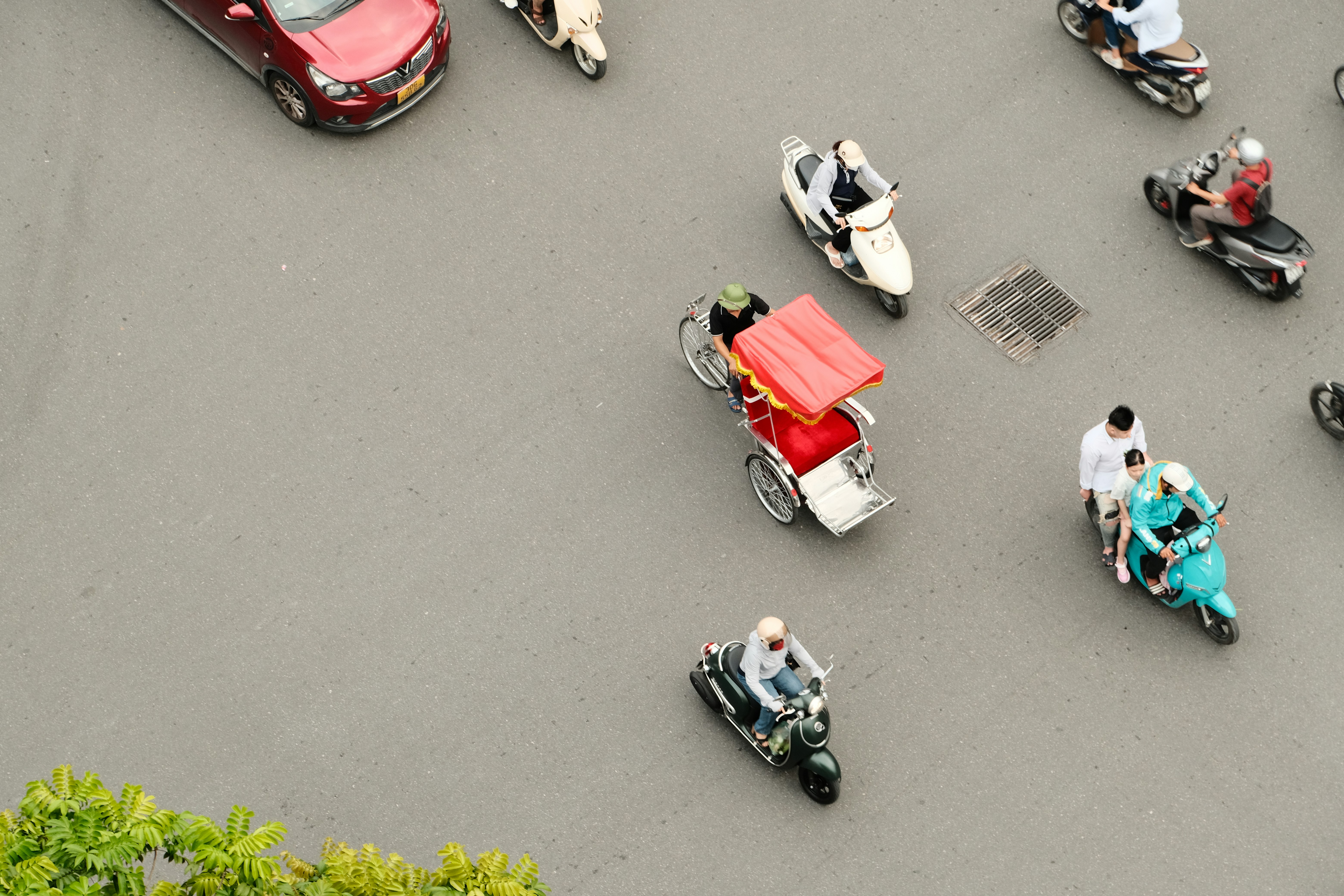A group of people riding motorcycles down a street