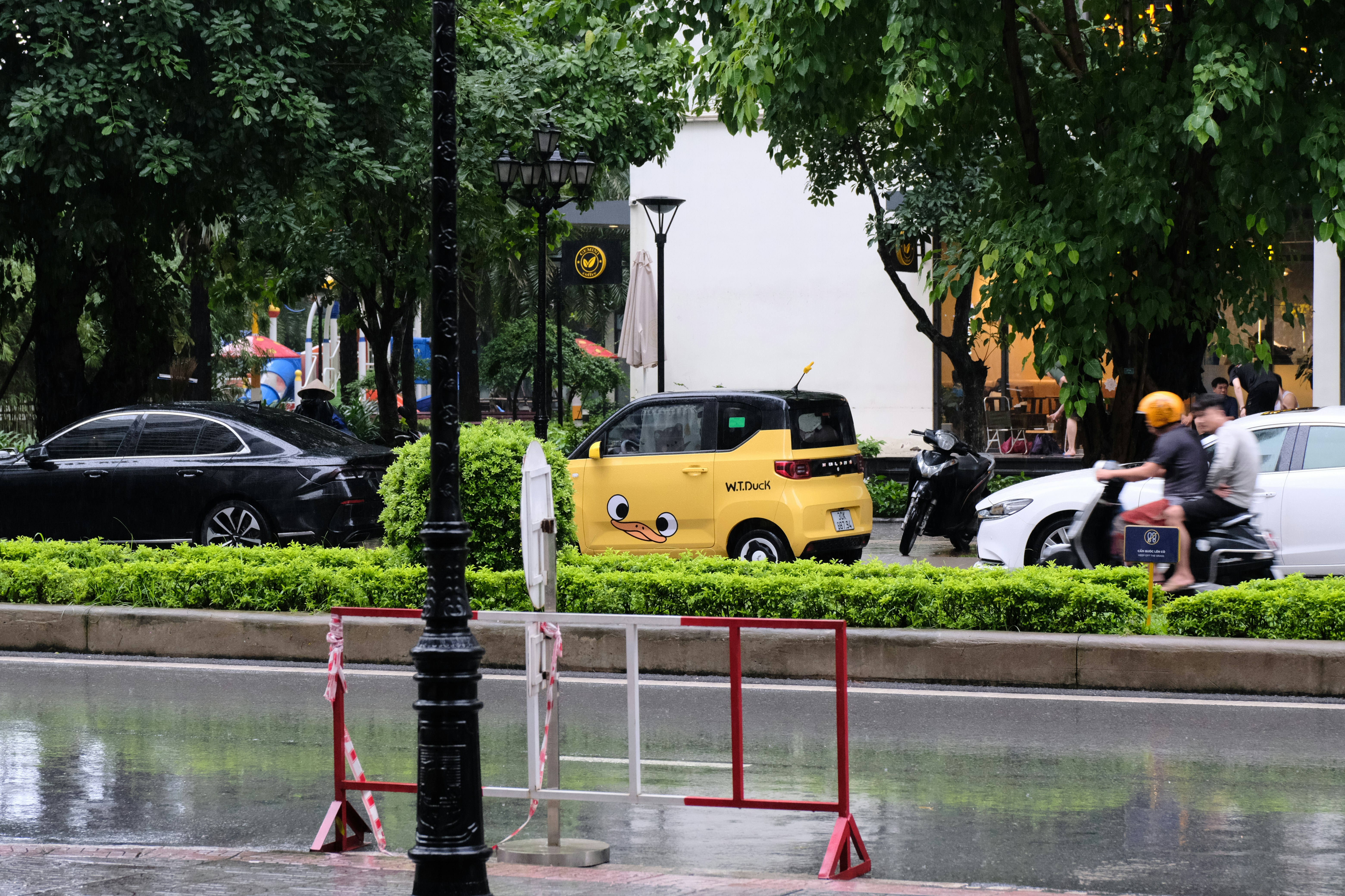 Smiling Yellow Taxi Peering Through a Rain-Washed City Street