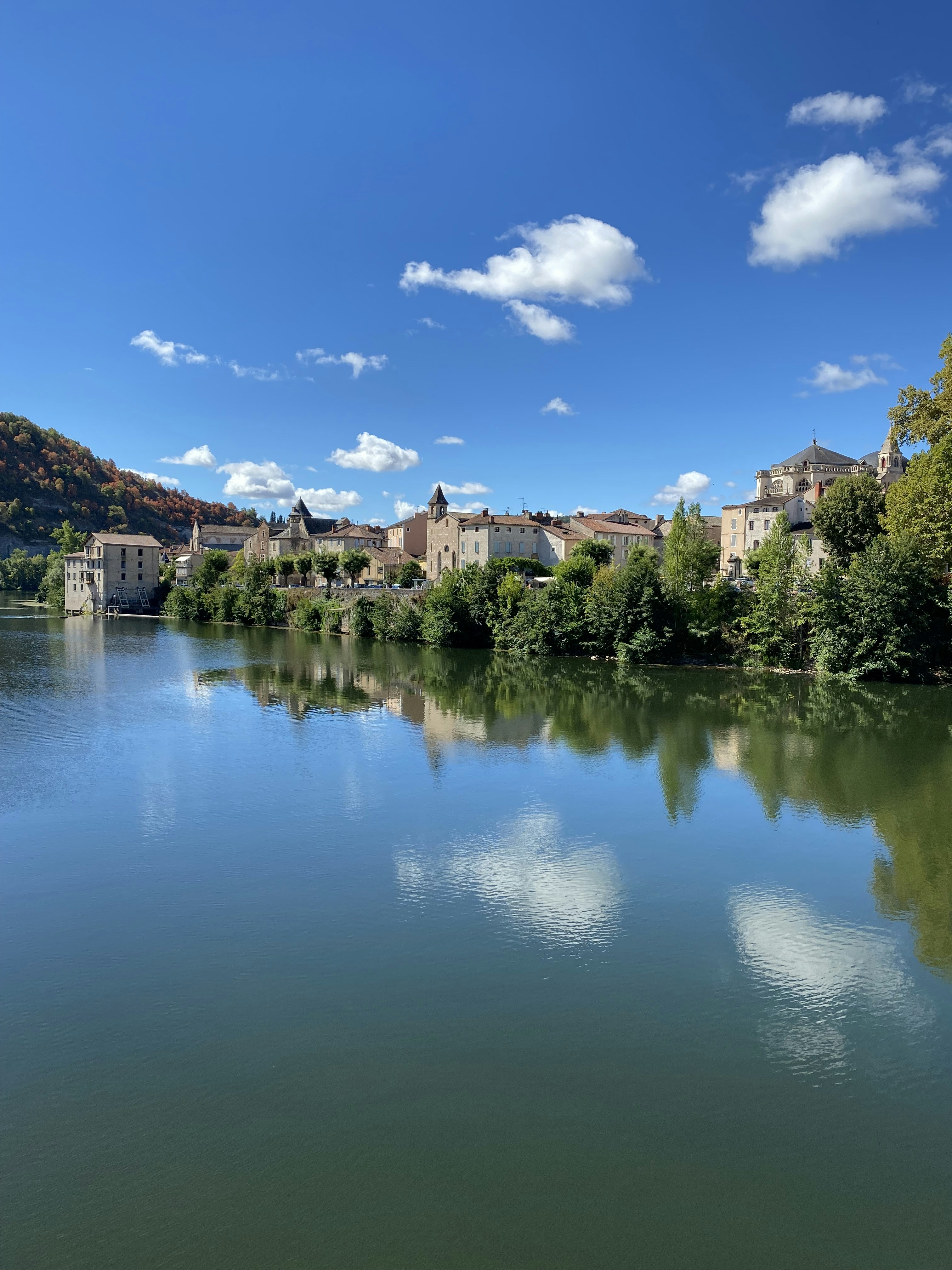 Riverside Heritage: A Sunlit Village Framed by Water and Sky