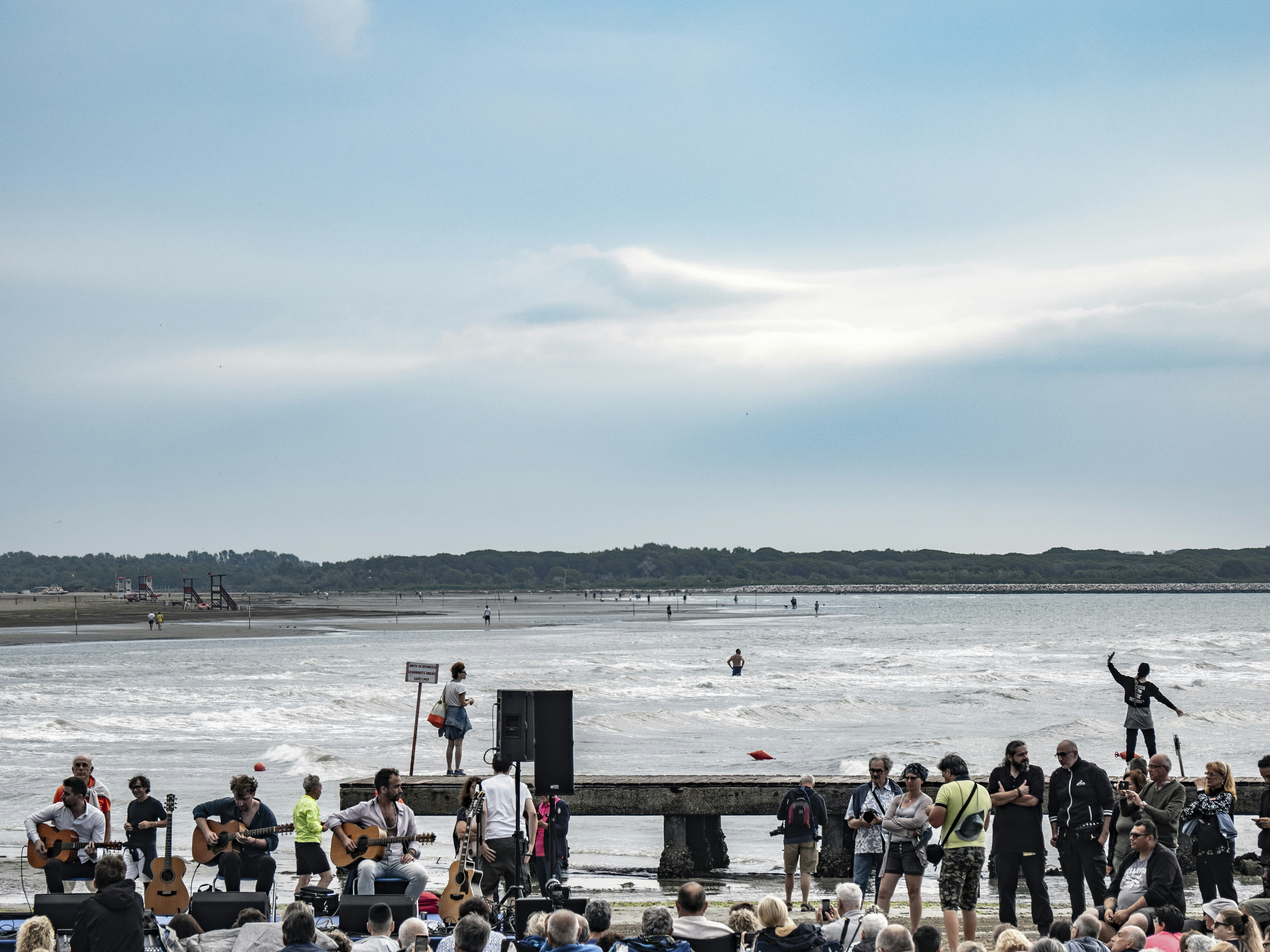A group of people standing on top of a beach photo – Free Blue Image on ...