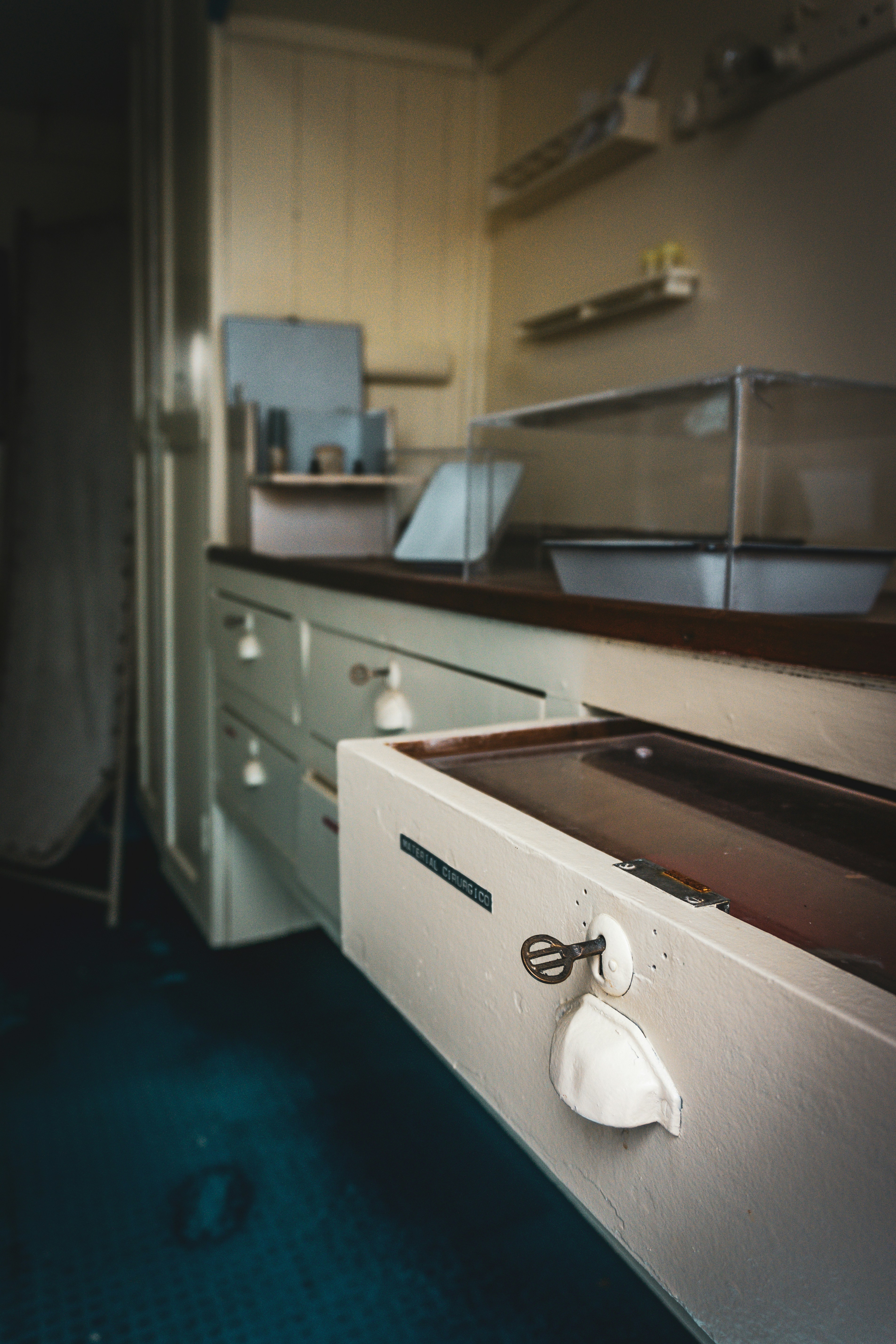 Open drawer revealing a vintage handle, set against a backdrop of an old-fashioned kitchen. The scene captures the essence of a bygone era.