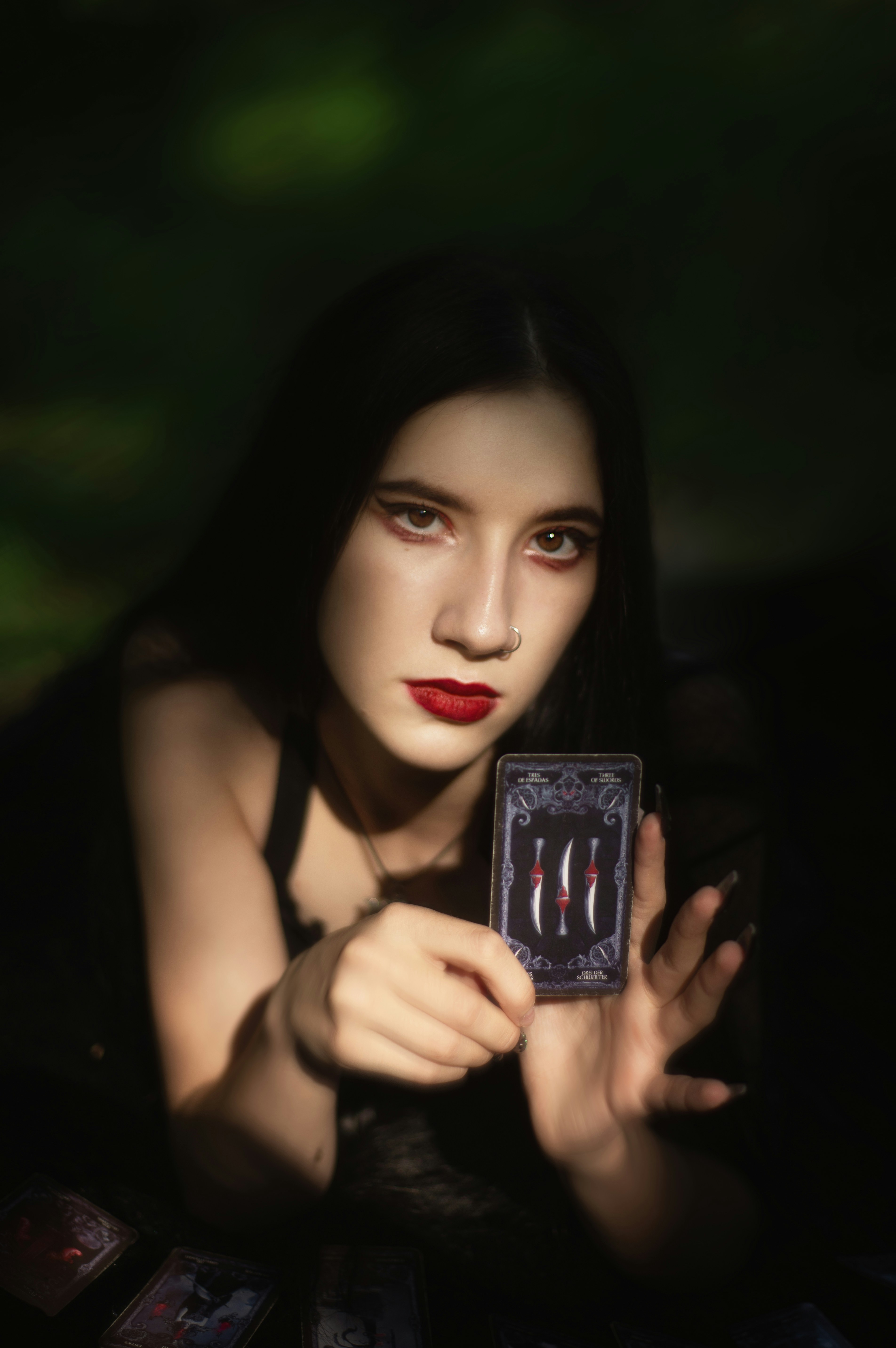 Crimson Gaze in Velvet Shadows: Tarot Cards and a Quiet Moment