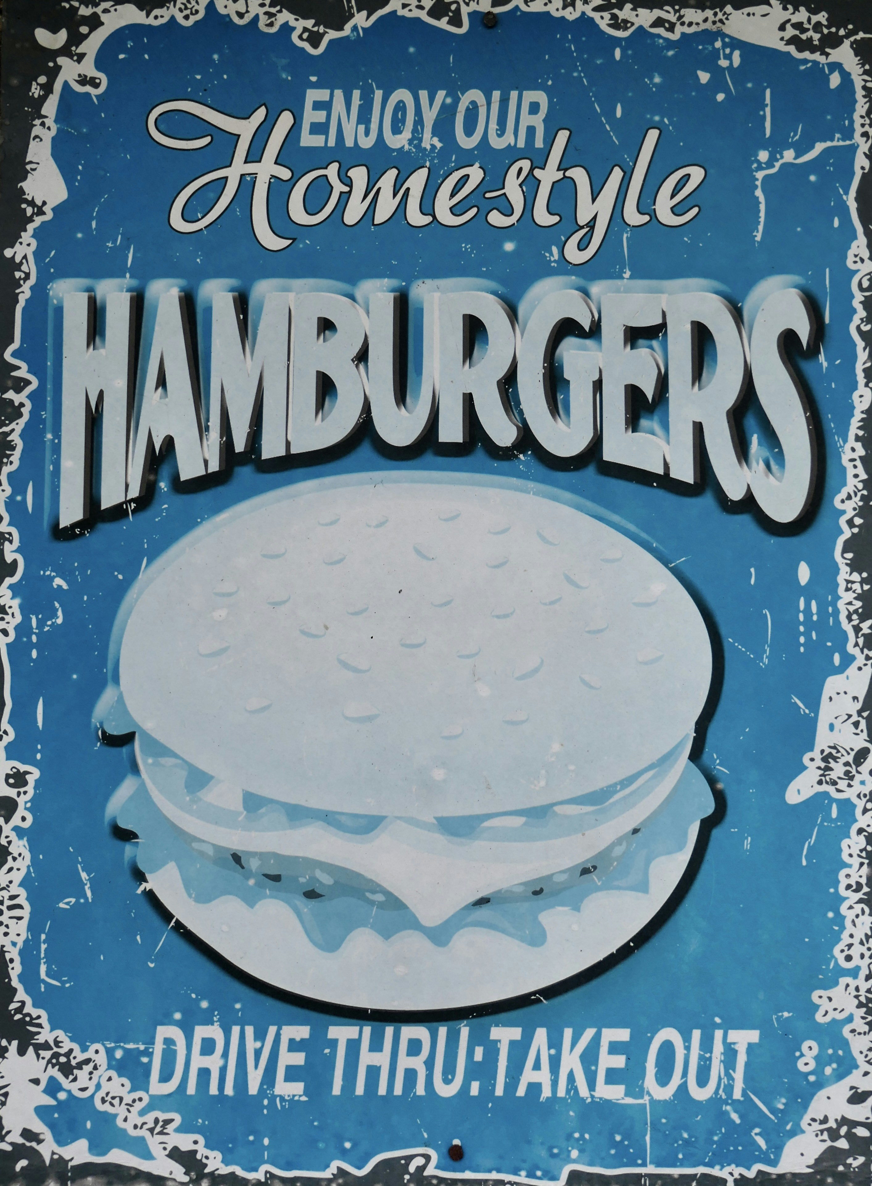 A sign for a hamburger restaurant on the side of a building photo ...