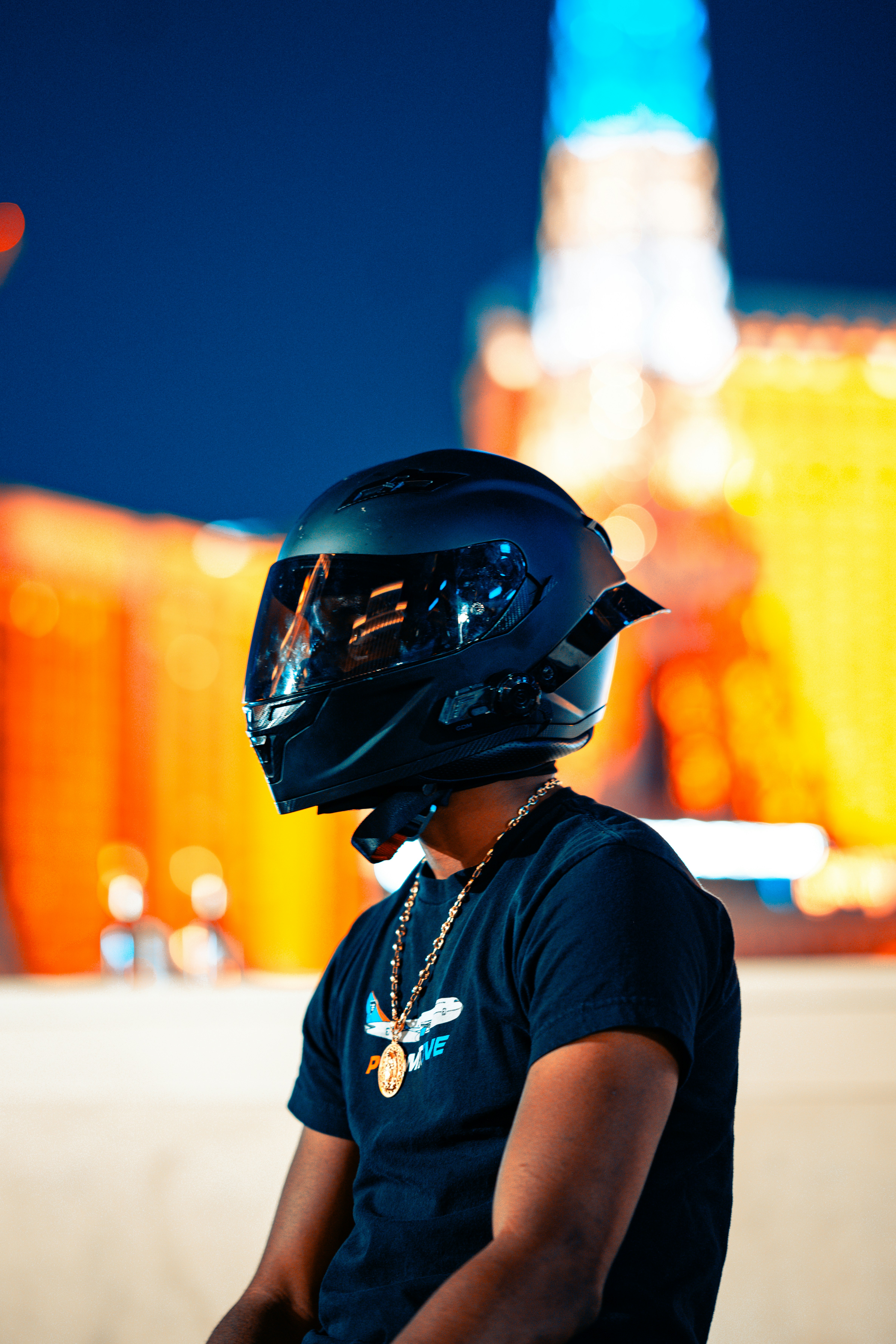 Neon Night Rider: A Helmeted Figure beneath City Glow