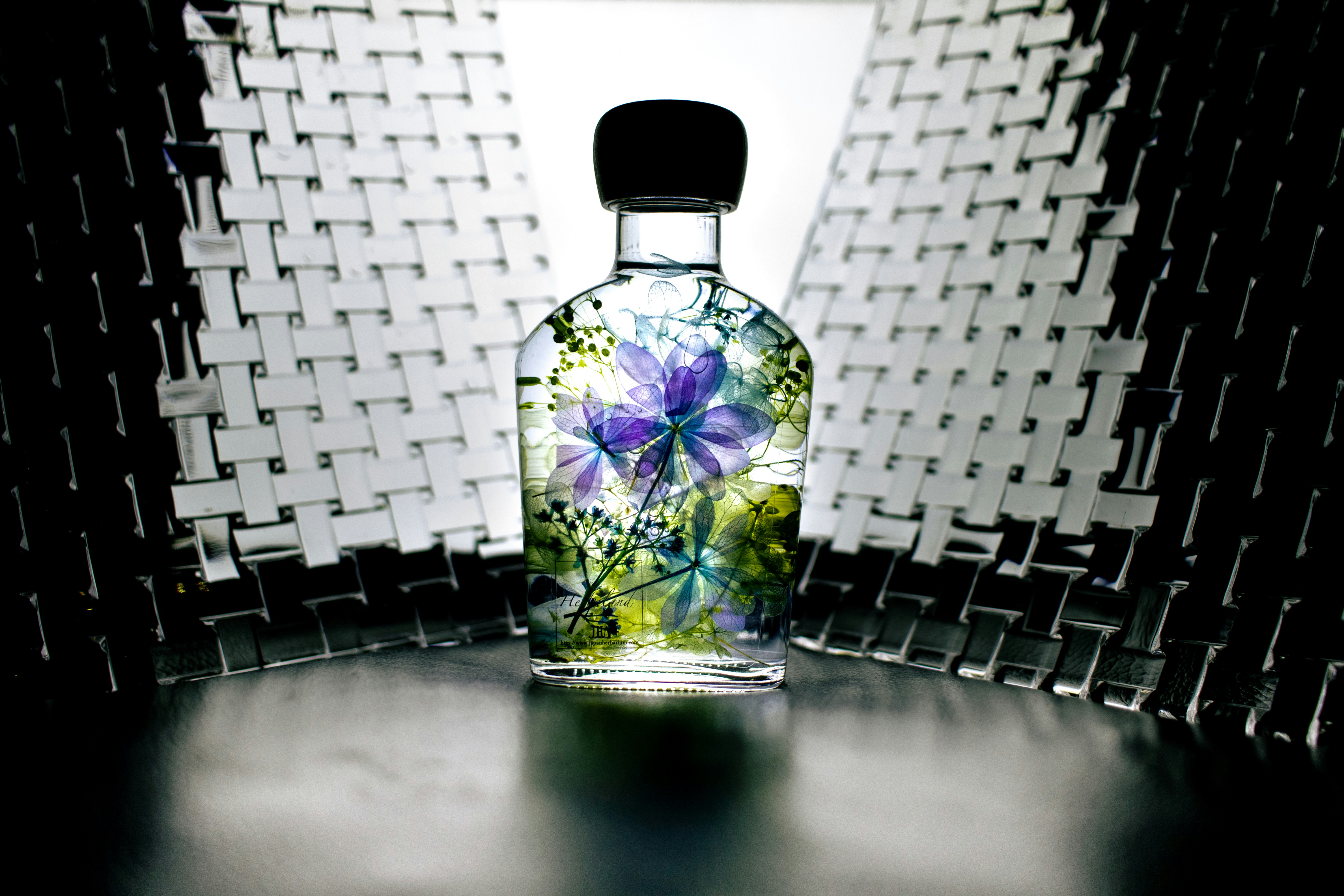 Glassbound Bloom: Perfume Bottle in a Gleaming Studio