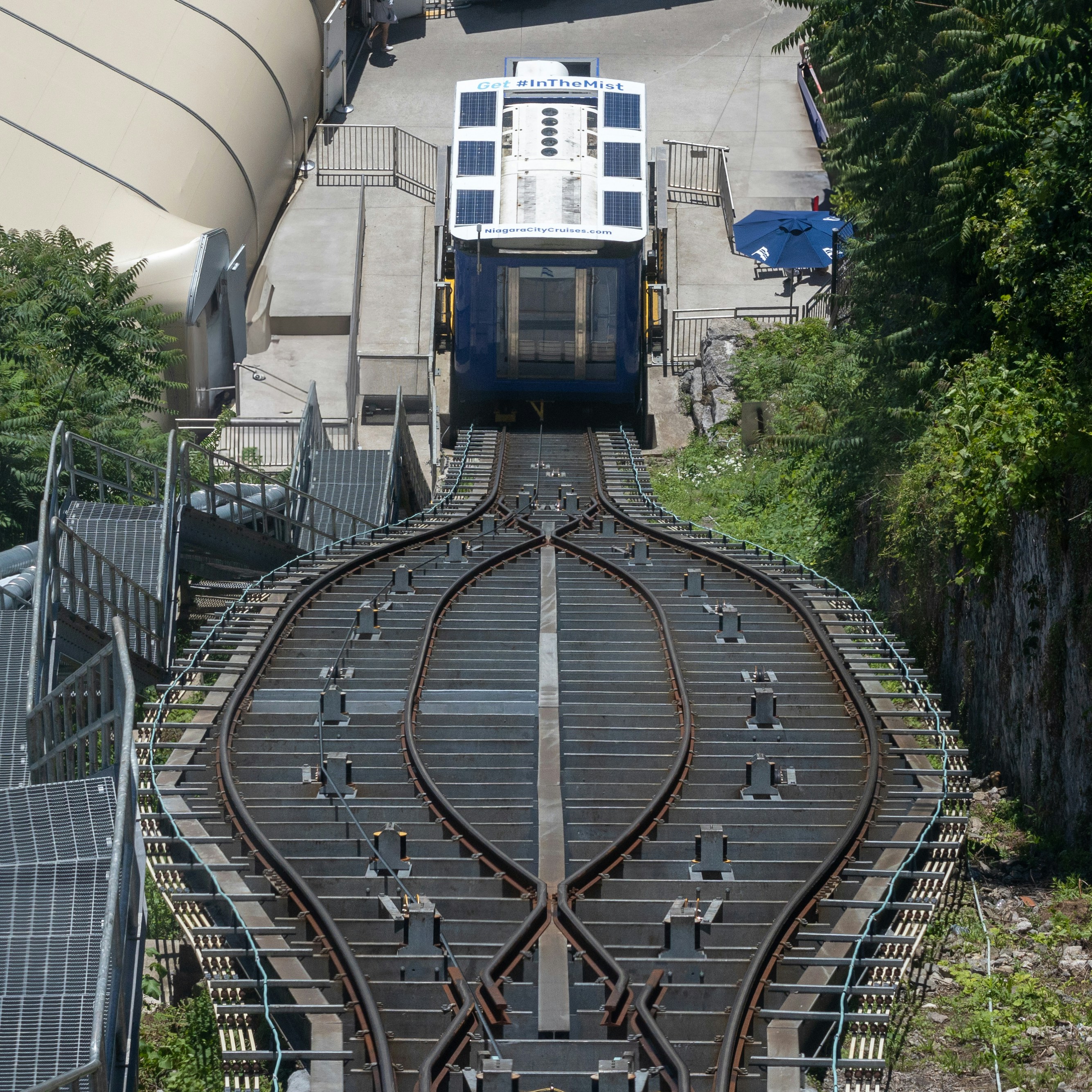 Converging Rails to the Summit: Aerial View of a Blue Funicular