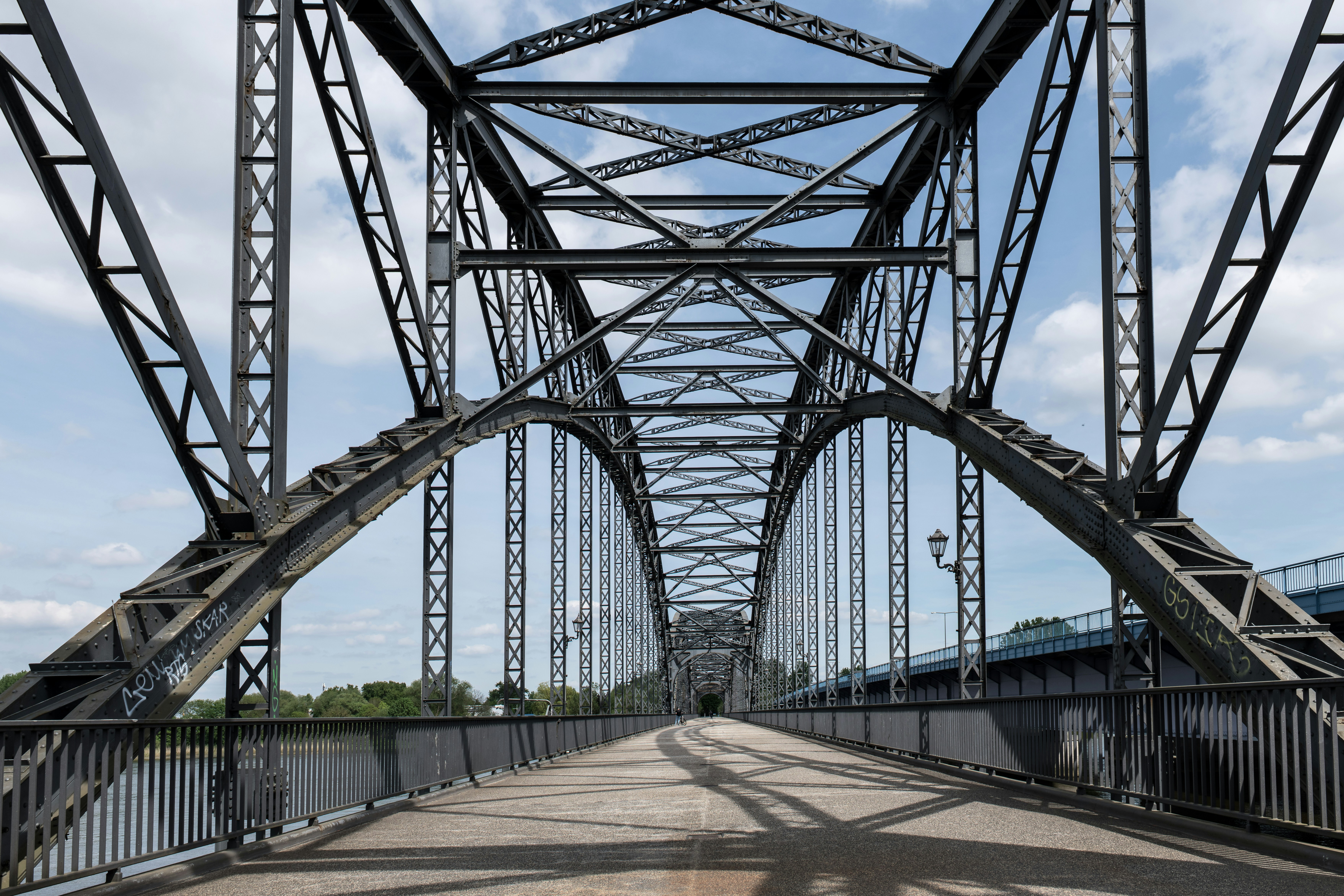 A large metal bridge over a river under a blue sky photo – Free Hamburg ...