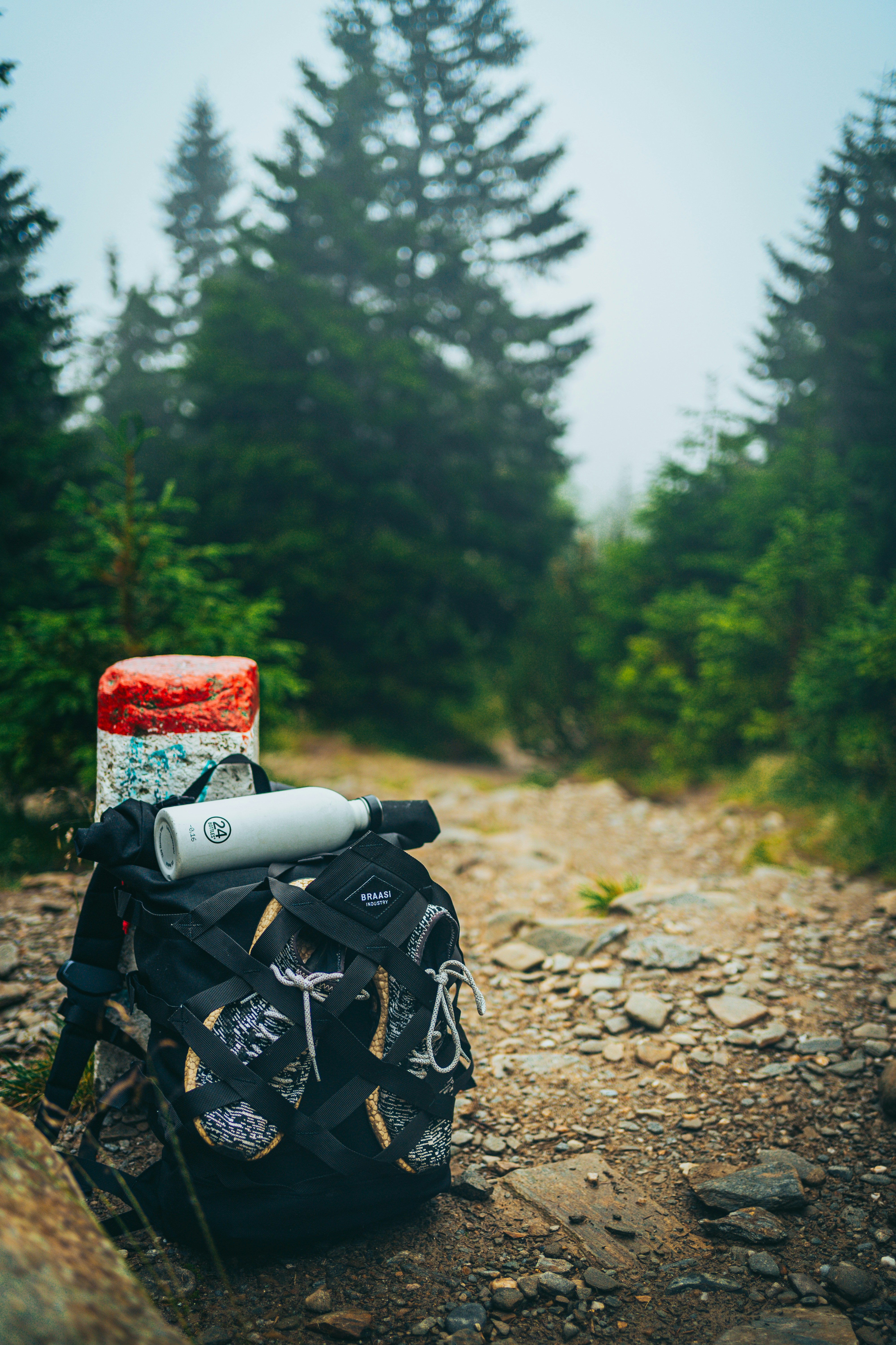 A backpack sitting on the side of a dirt road photo – Free Krkonossky ...