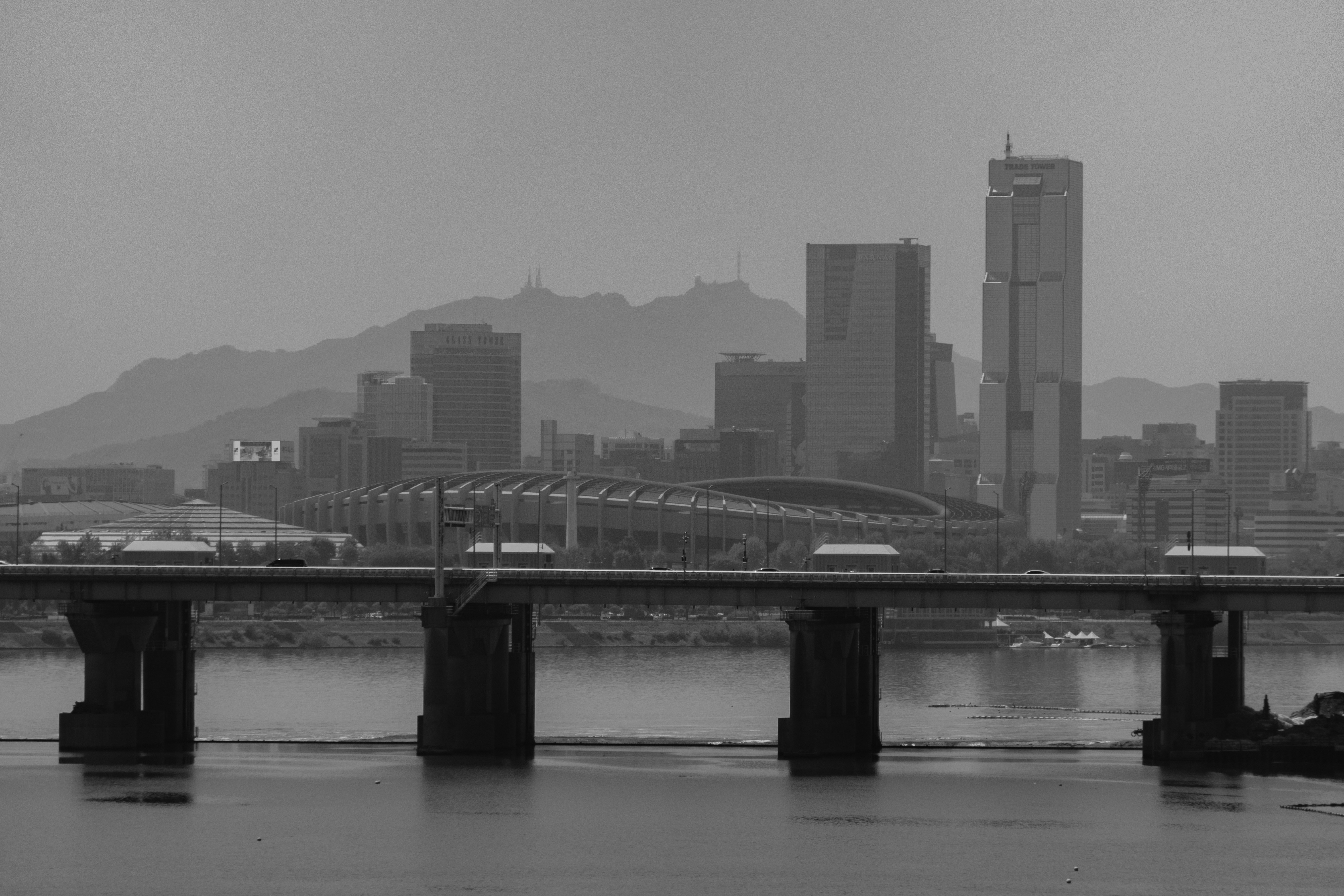 Span of Silence: A Monochrome Cityscape Crossing the River