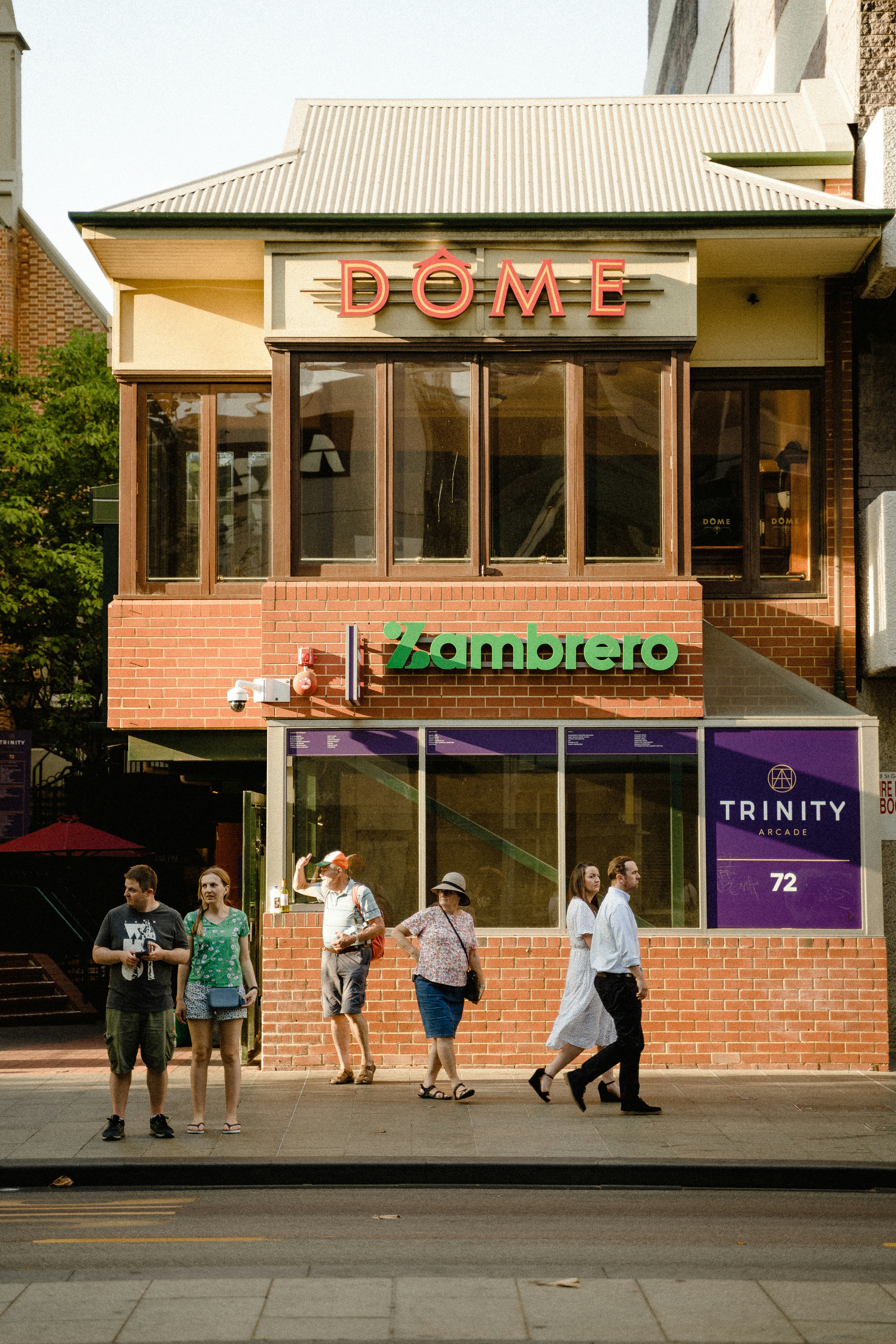 A group of people standing outside of a building