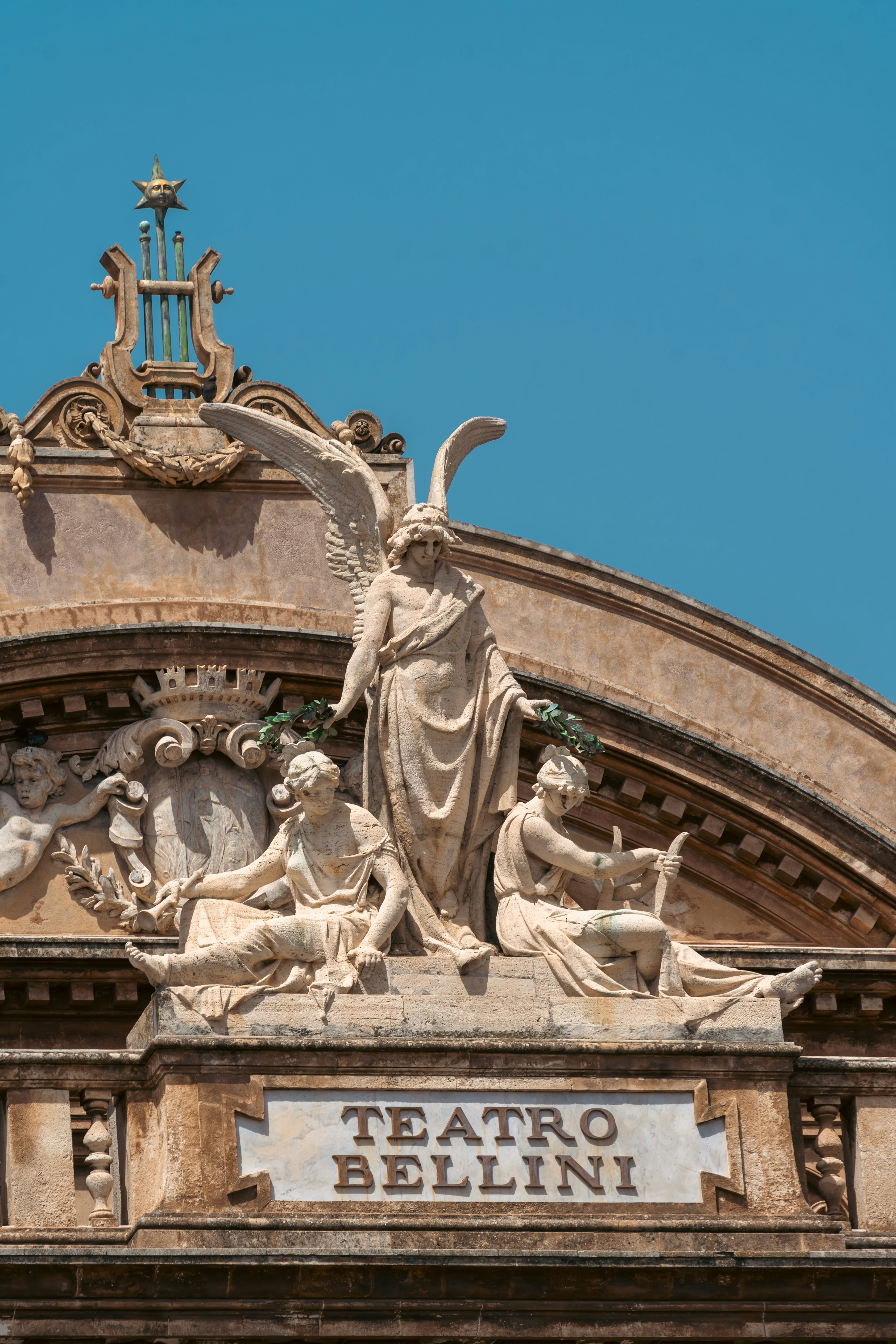 A close up of a building with statues on it photo – Free Teatro bellini ...