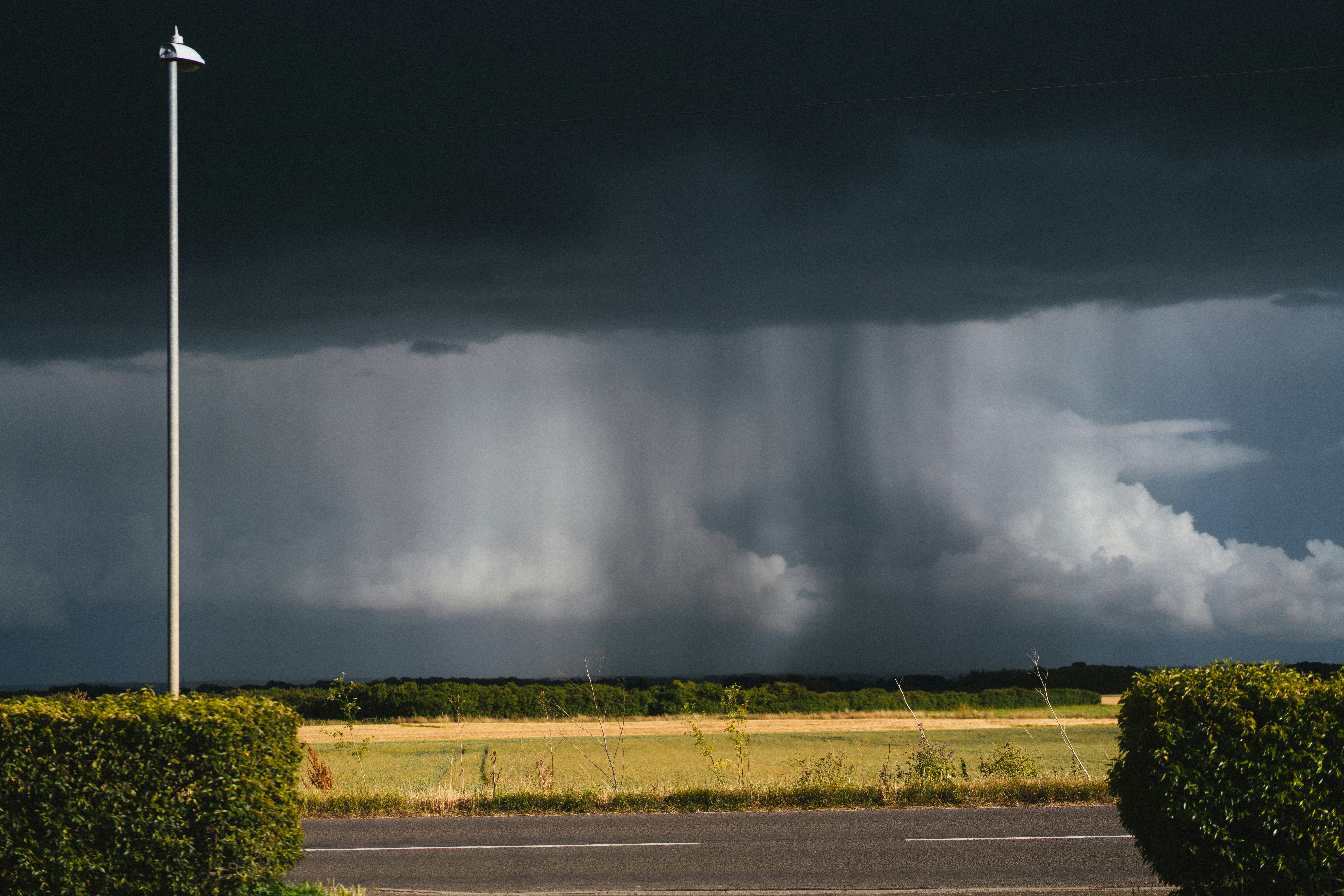 A storm moving across the sky over a road photo – Free Grey Image on ...