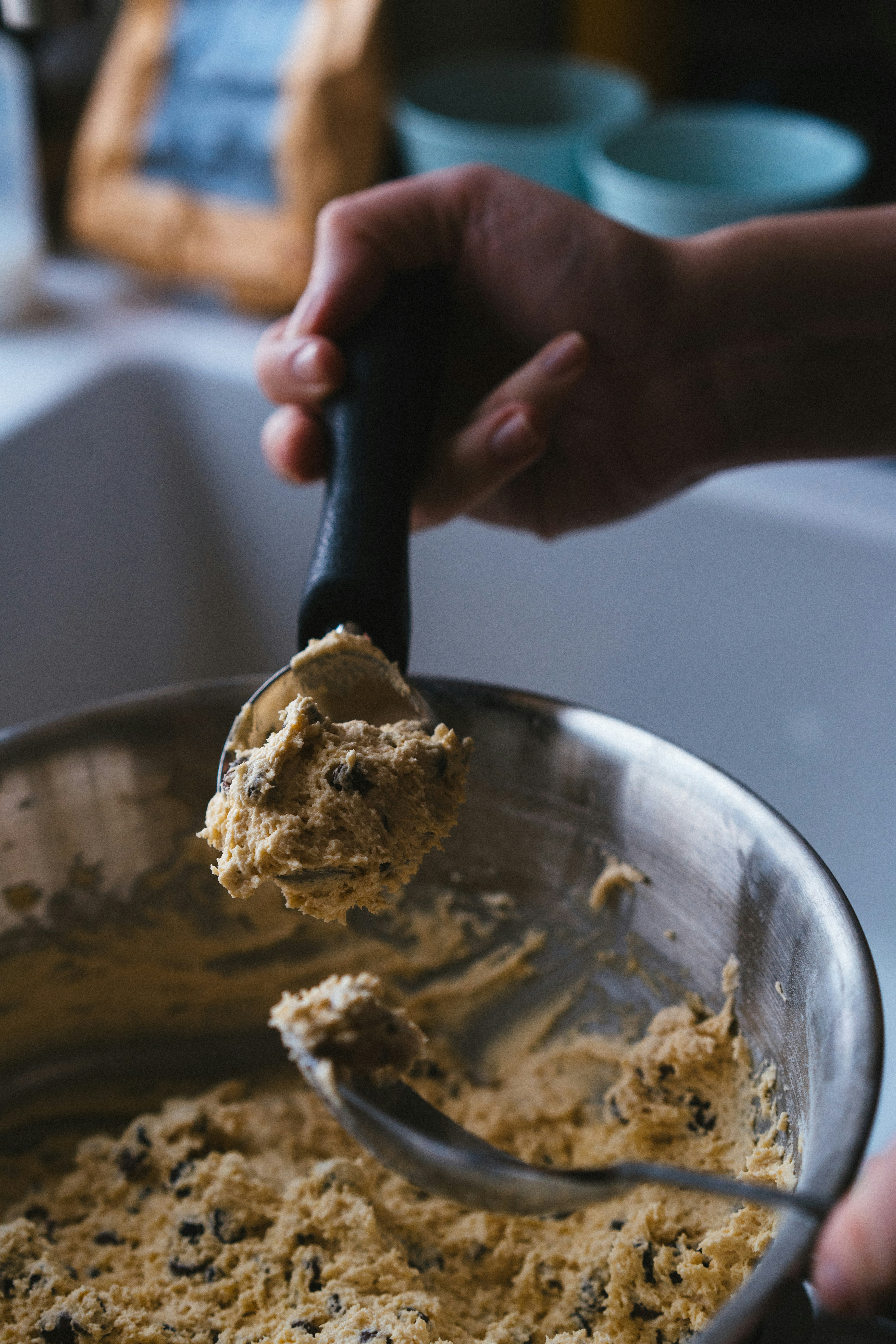 A person mixing something in a metal bowl photo – Free Grey Image on ...