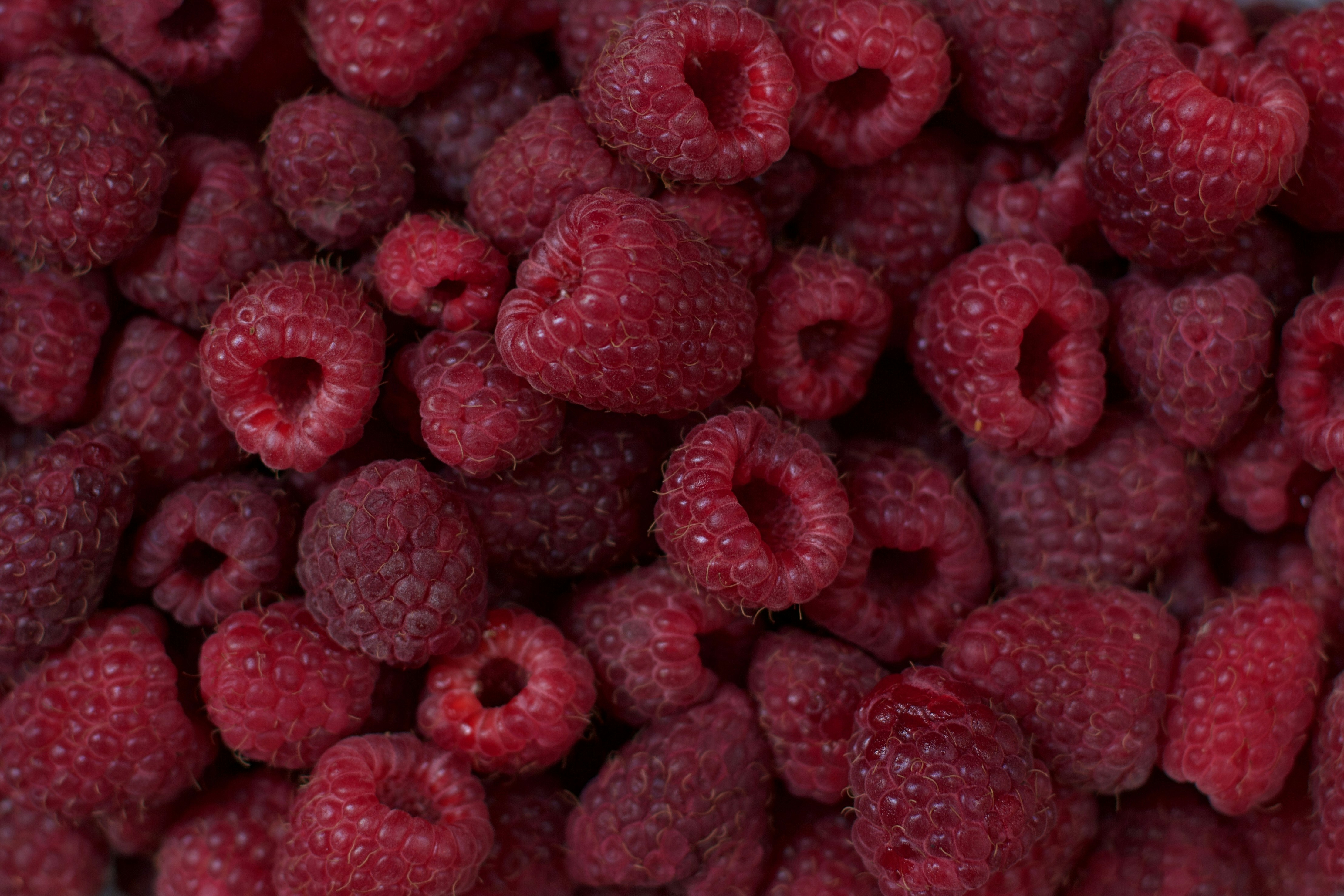 Fresh raspberries from the farmers market | A pile of raspberries sitting on top of a table