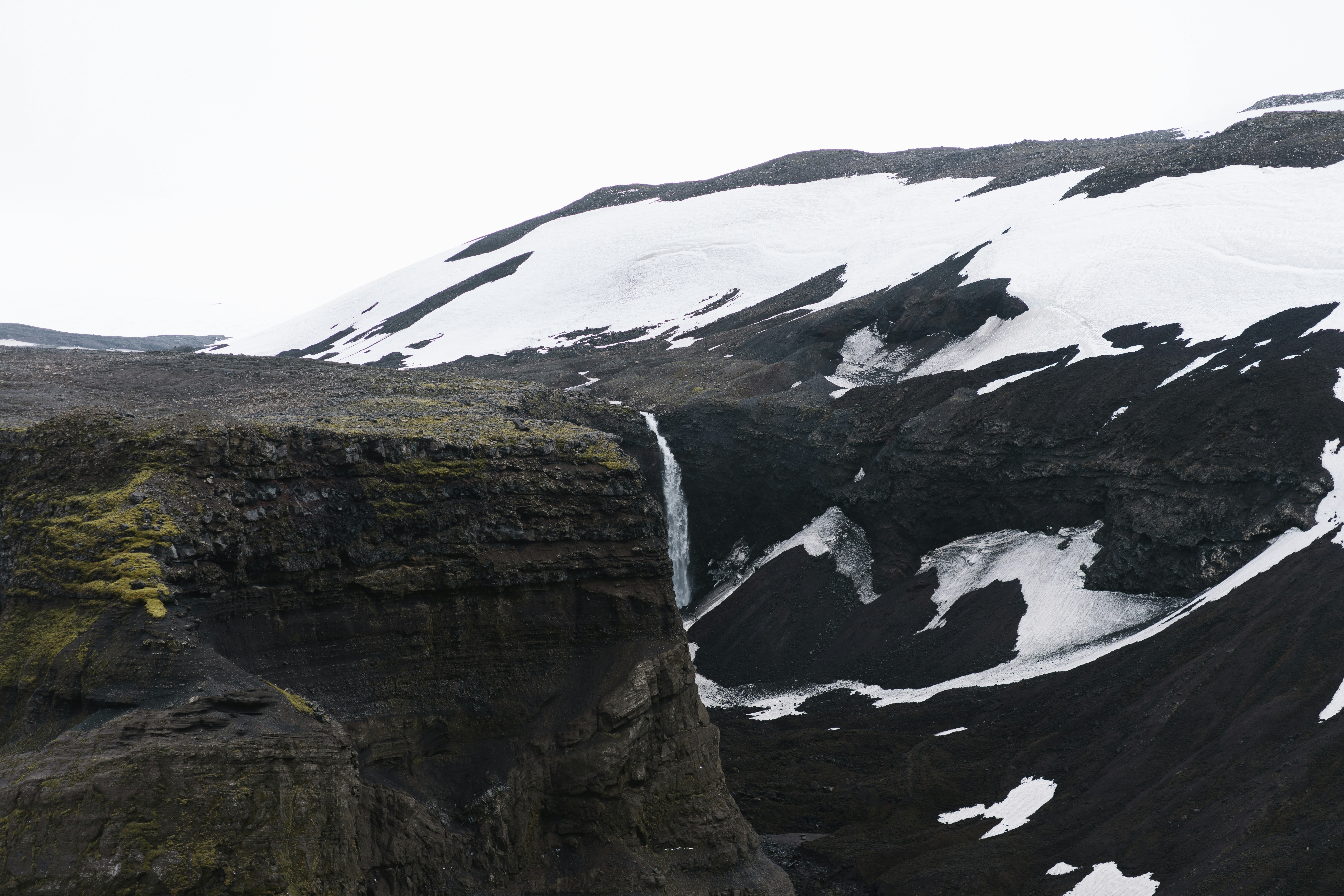 Icy Cascade Atop the Dark Cliff