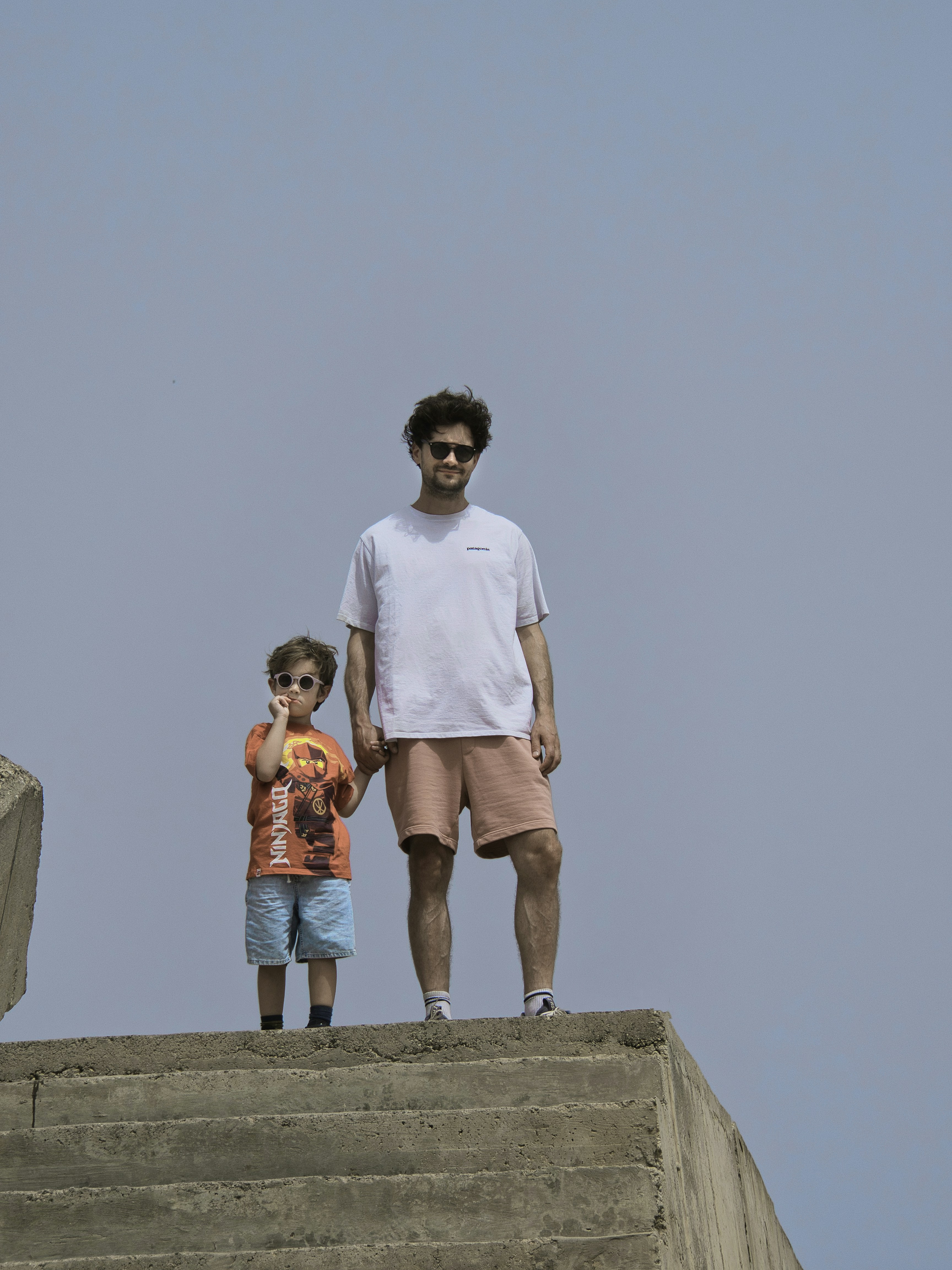 Parents on the Edge: A Quiet Balcony Moment