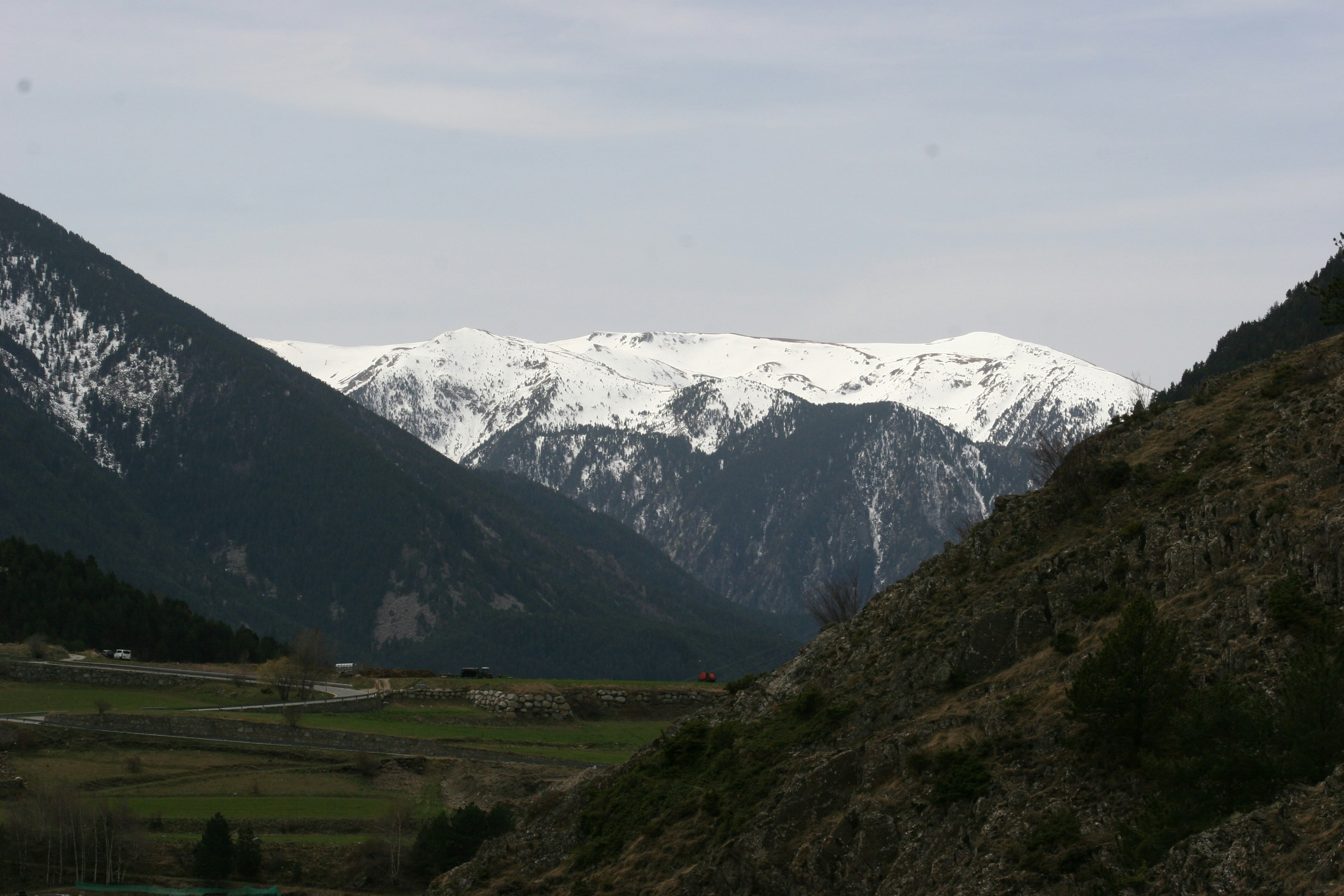 Snow-Crowned Peaks Framing a Quiet Valley Road