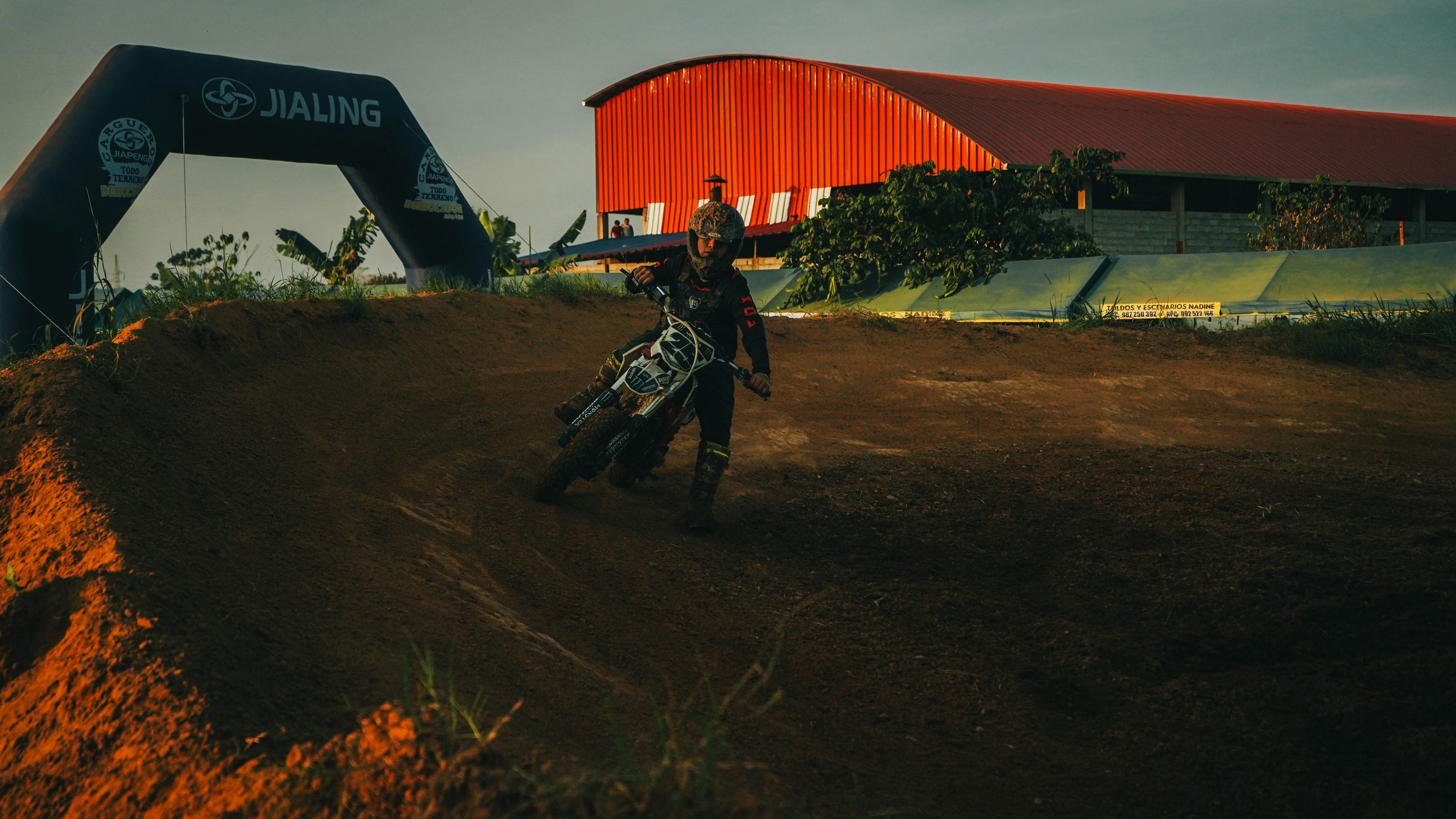 Dust Trail Dance: A Dirt Bike Leans Through a Sunset Turn