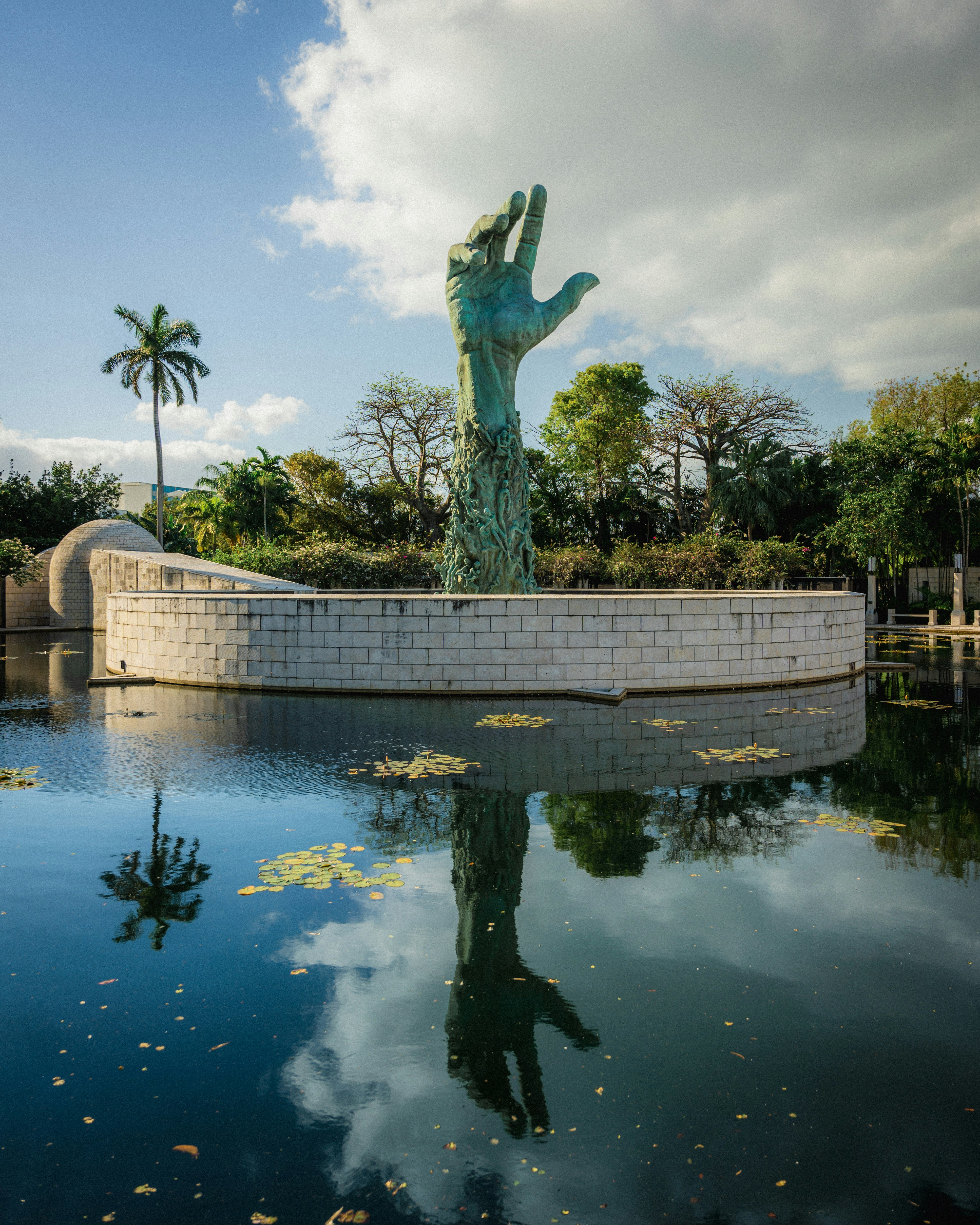 A statue of a person reaching up into the sky photo – Free Sunset Image ...