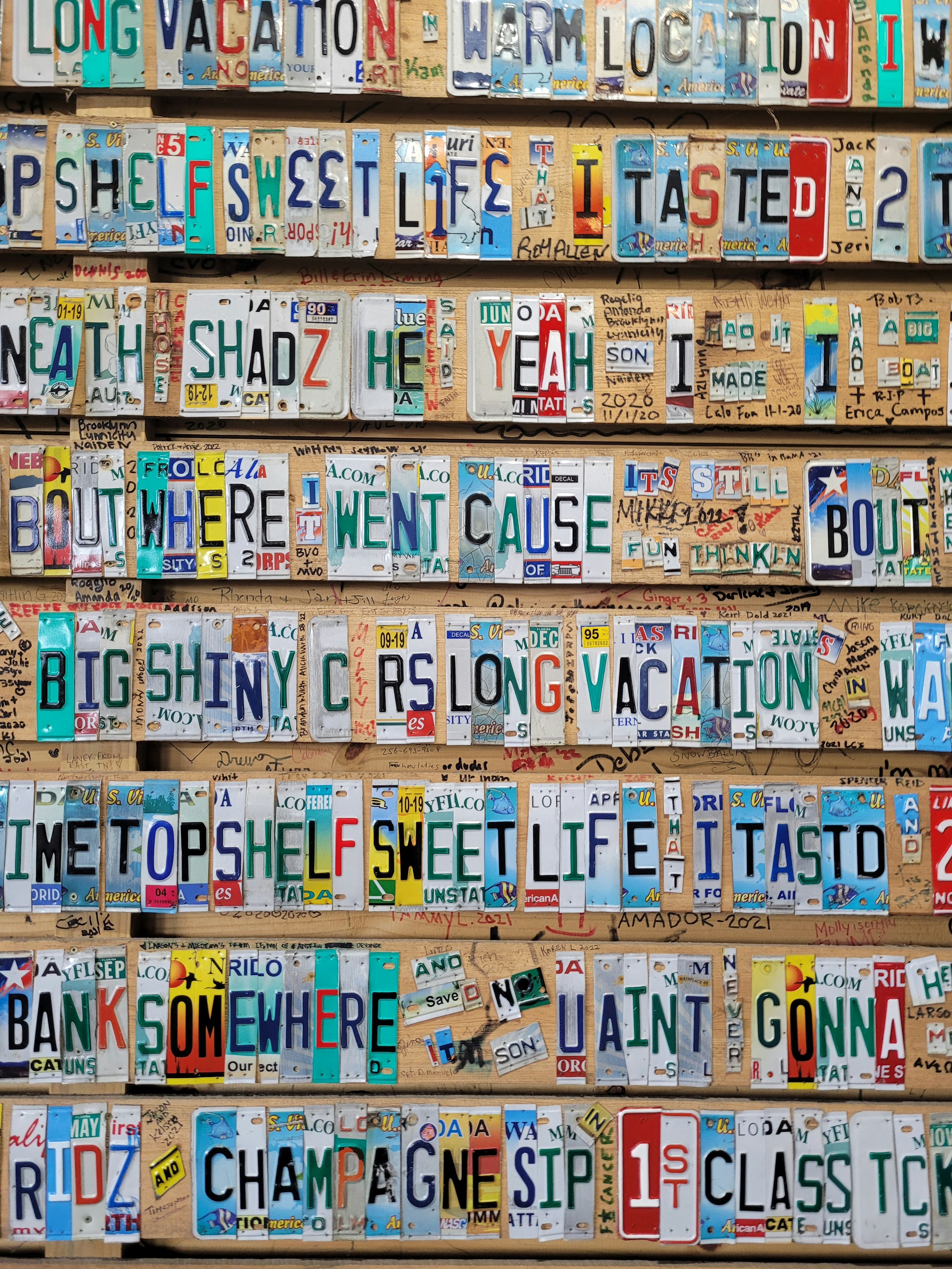 Many license plates are stacked on top of each other