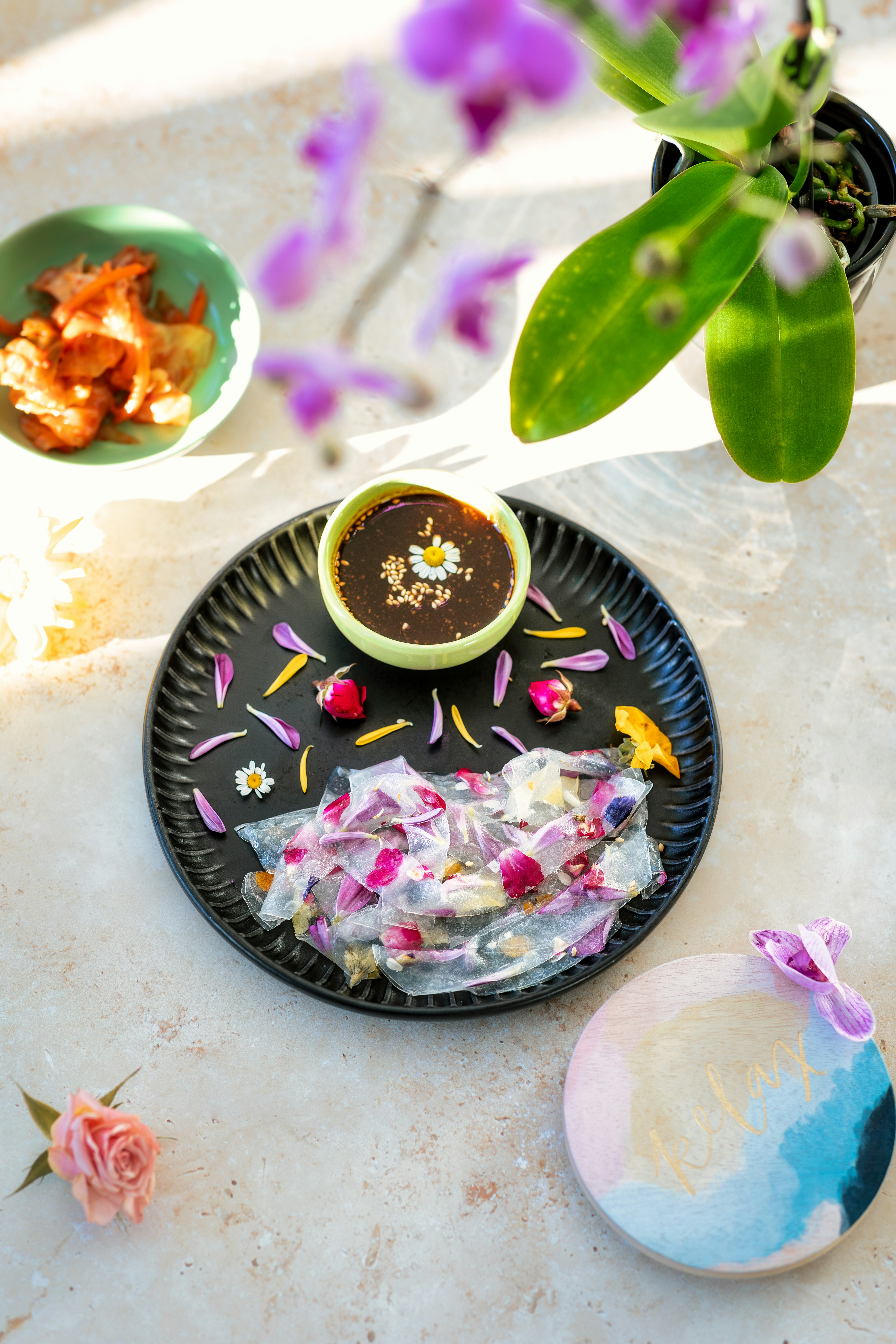 A Delicate Crescendo: Chocolate Dip and Petals on a Black Plate