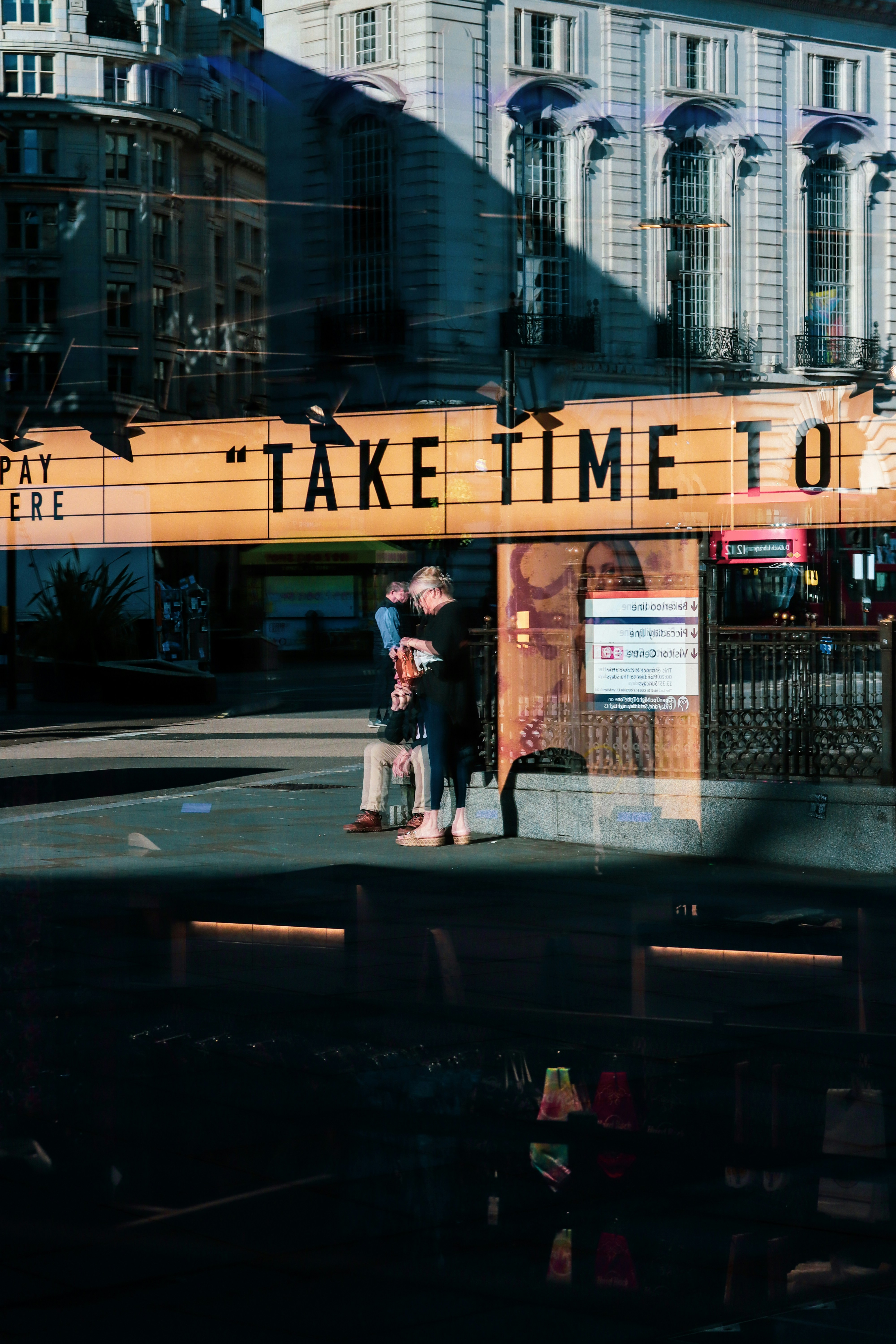 A couple of people standing in front of a sign photo – Free Portrait ...