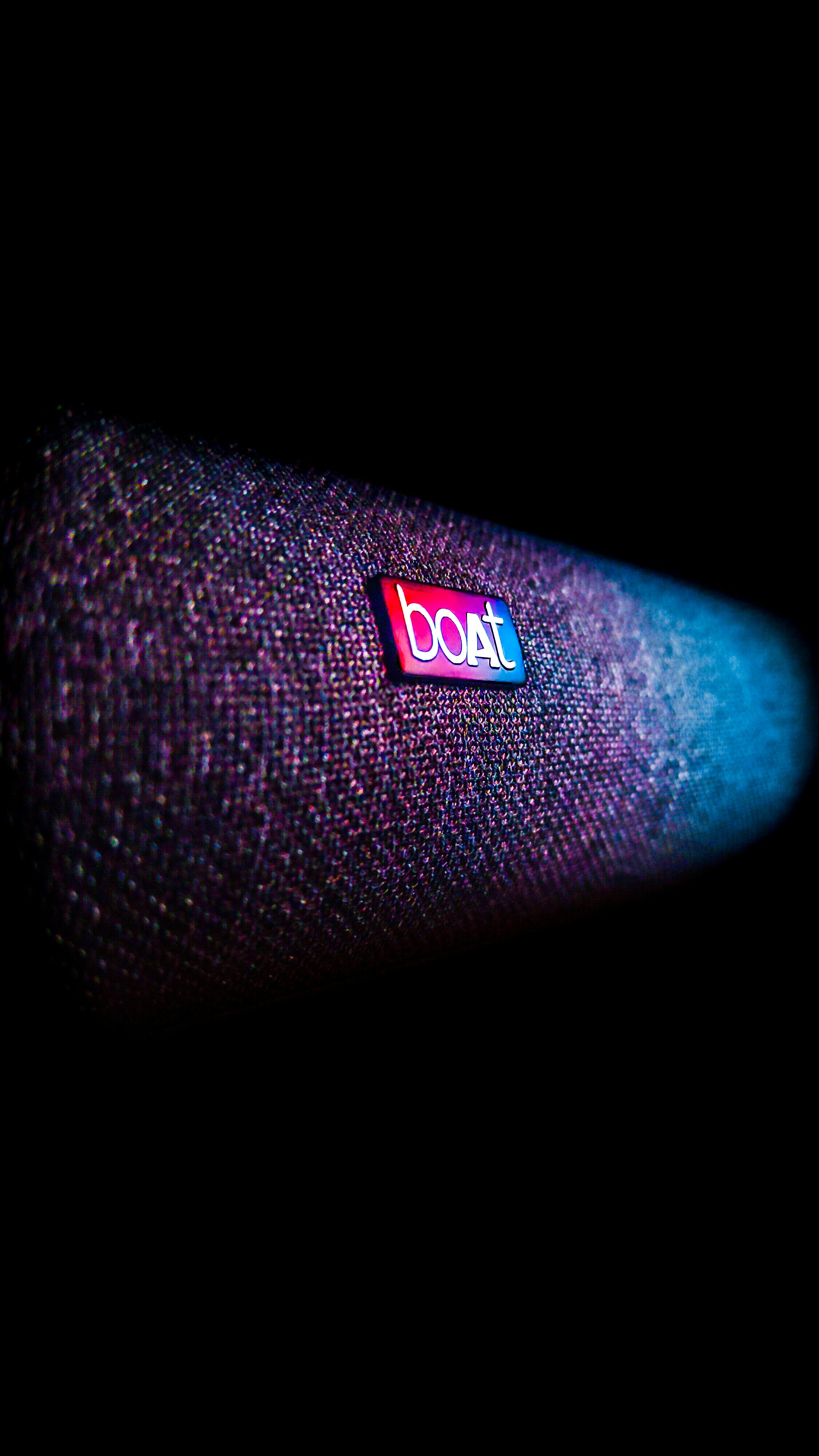Glowing Boombox Badge on Textured Speaker Surface