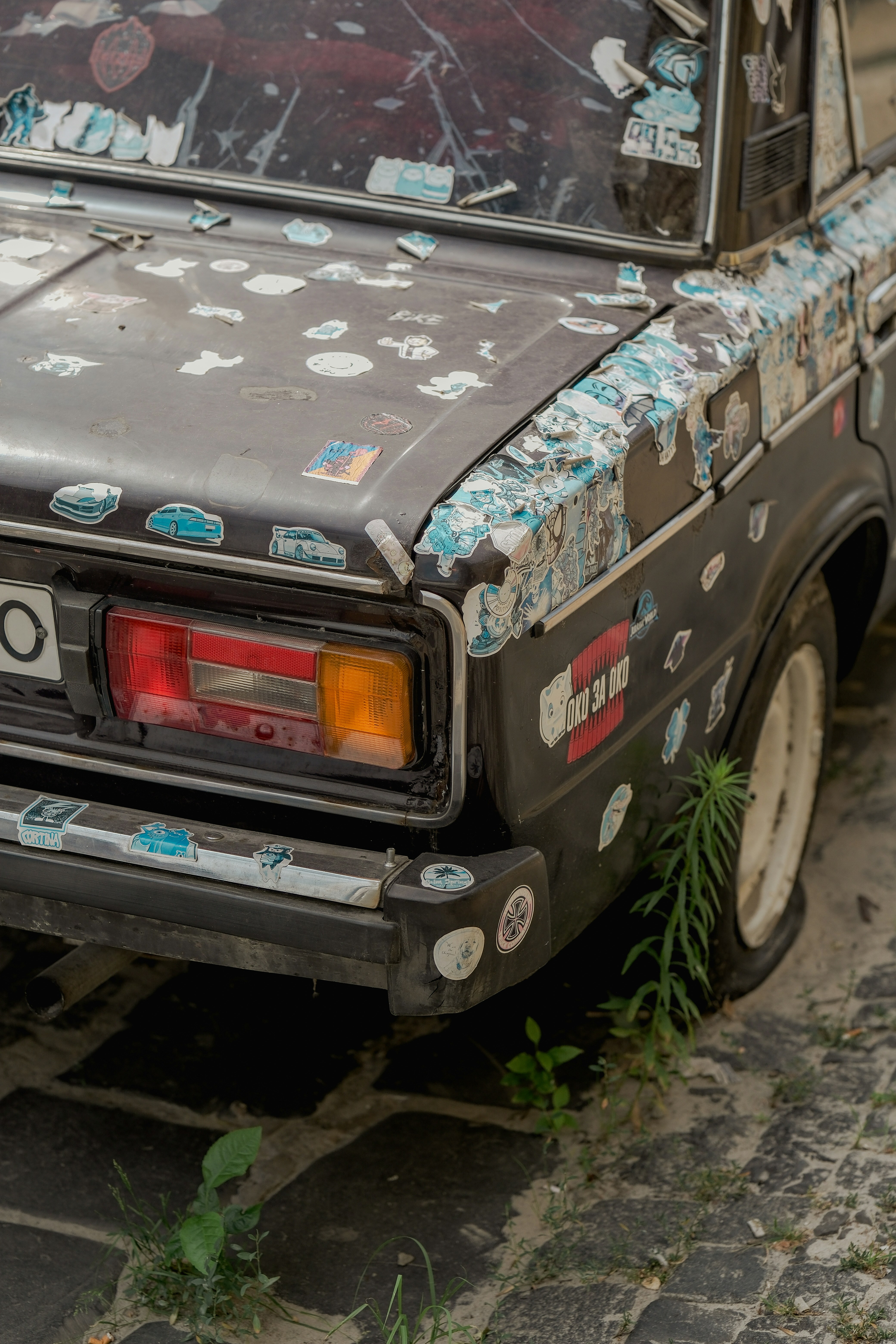 Stickered Relic on Cracked Pavement: A Quiet Auto Portrait