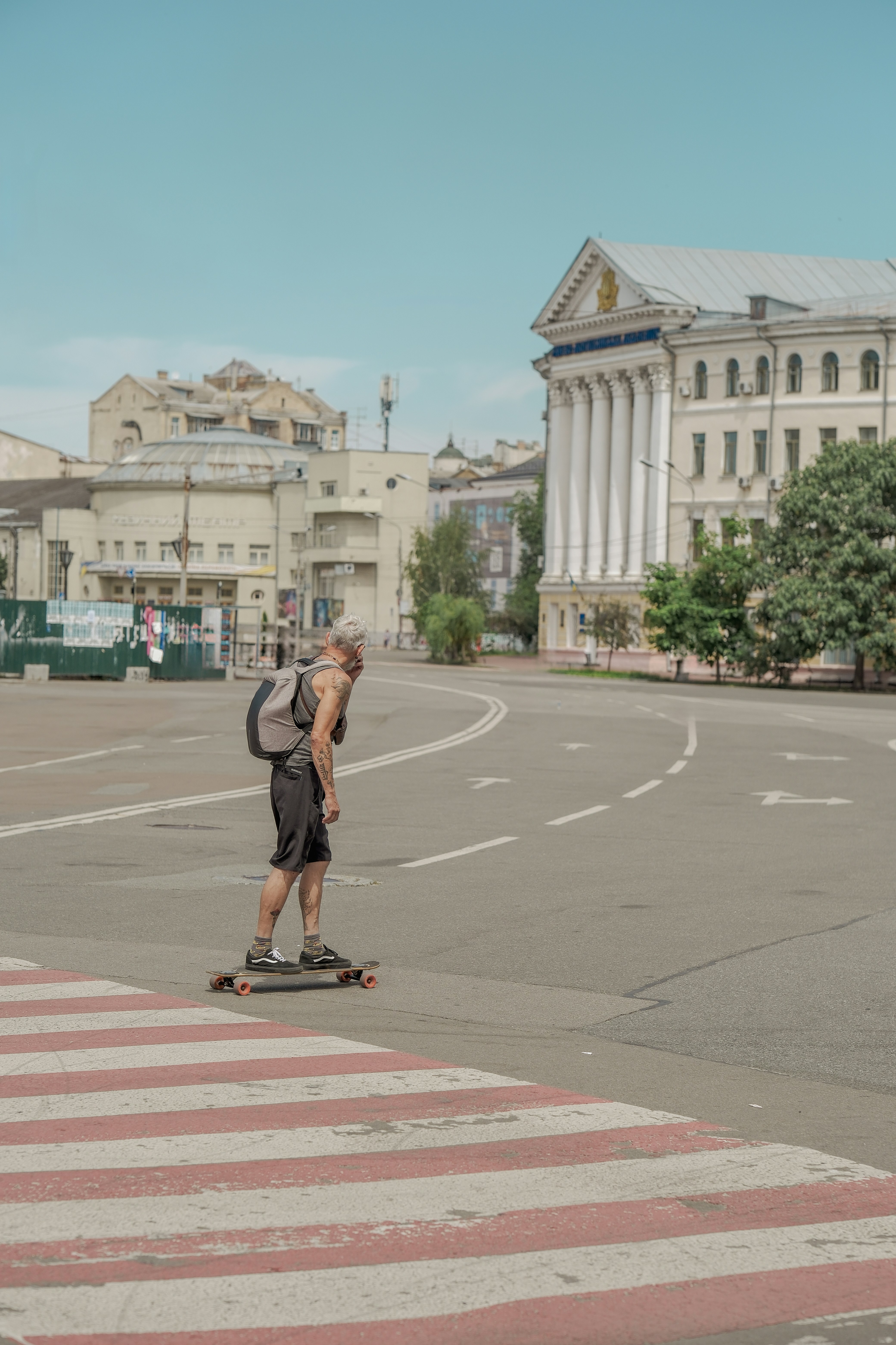 Skateboarder at a Quiet City Crossing