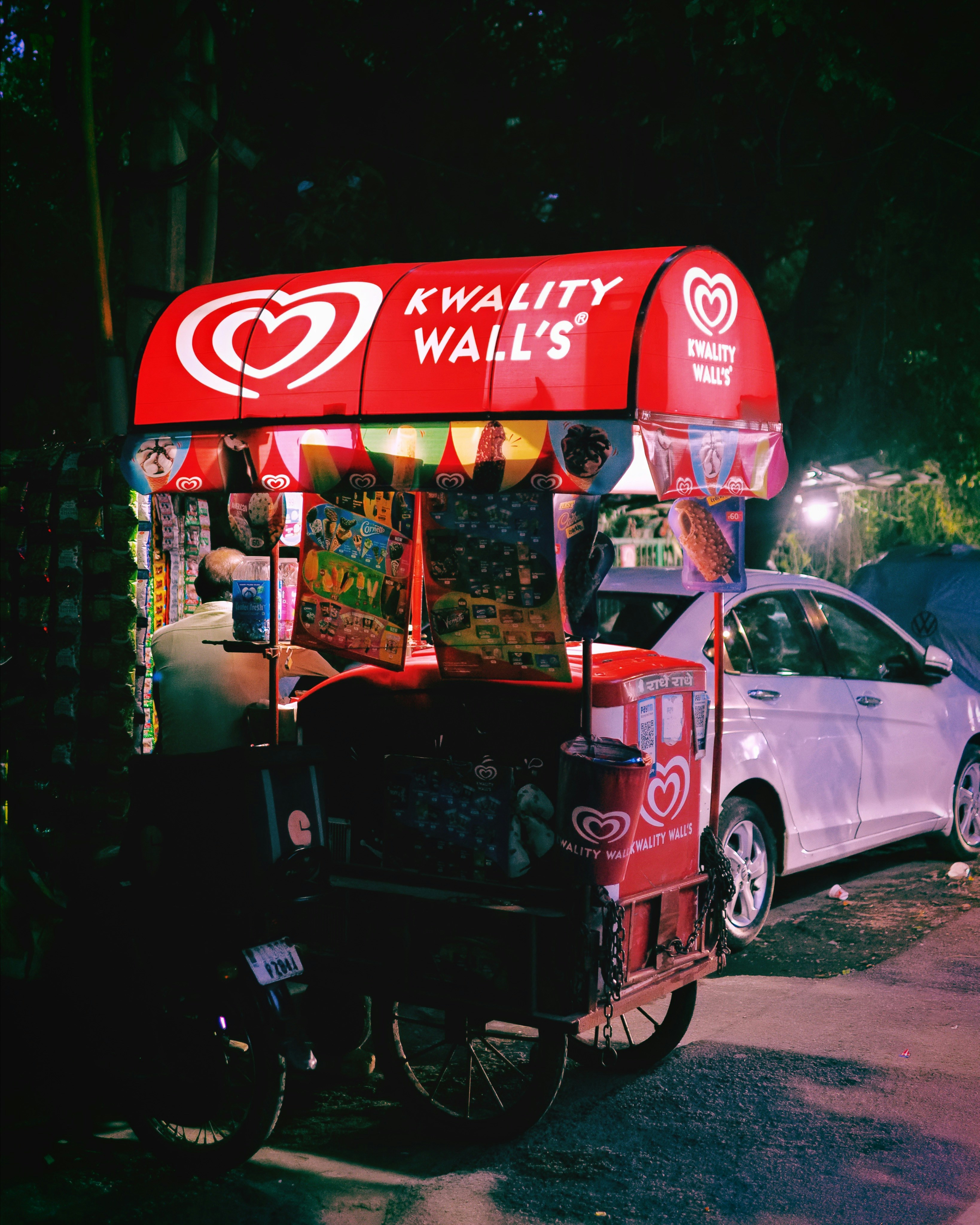 Red Canopy at Night: Kwality Walls Ice Cream Cart in Neon Light