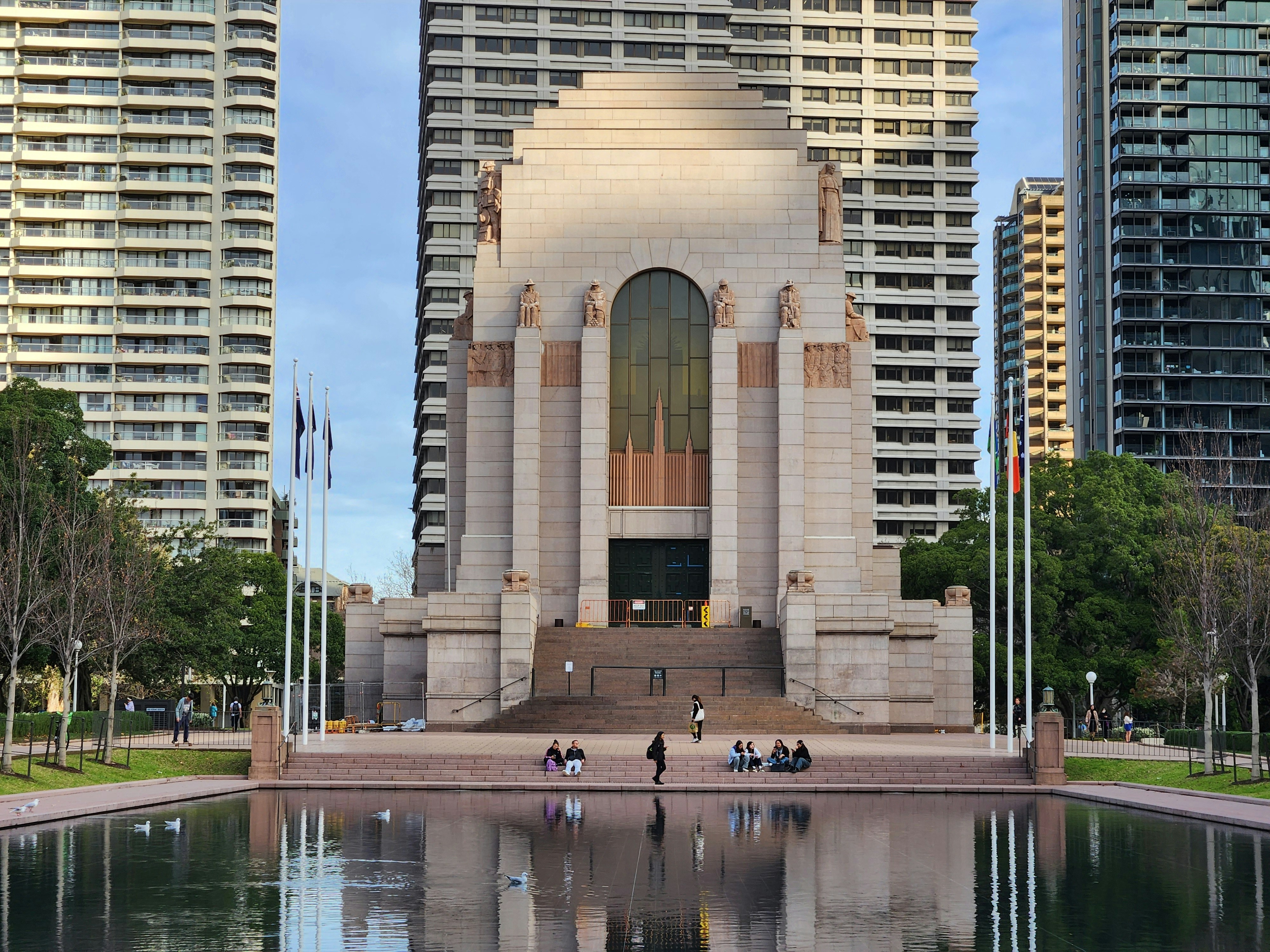A monument in the middle of a lake surrounded by tall buildings photo ...